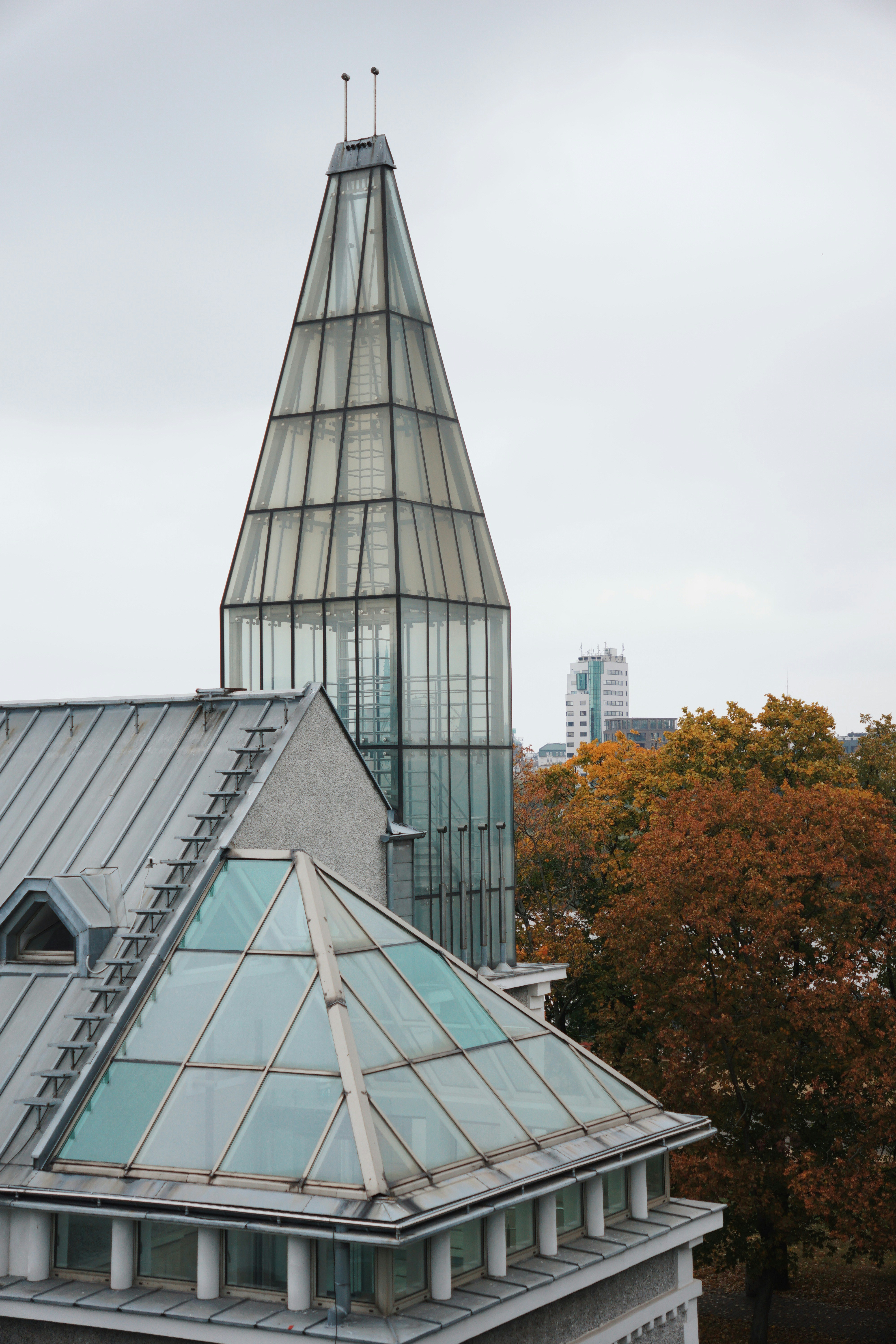 Glass-towered Atrium Rises Above Autumn Rooftops