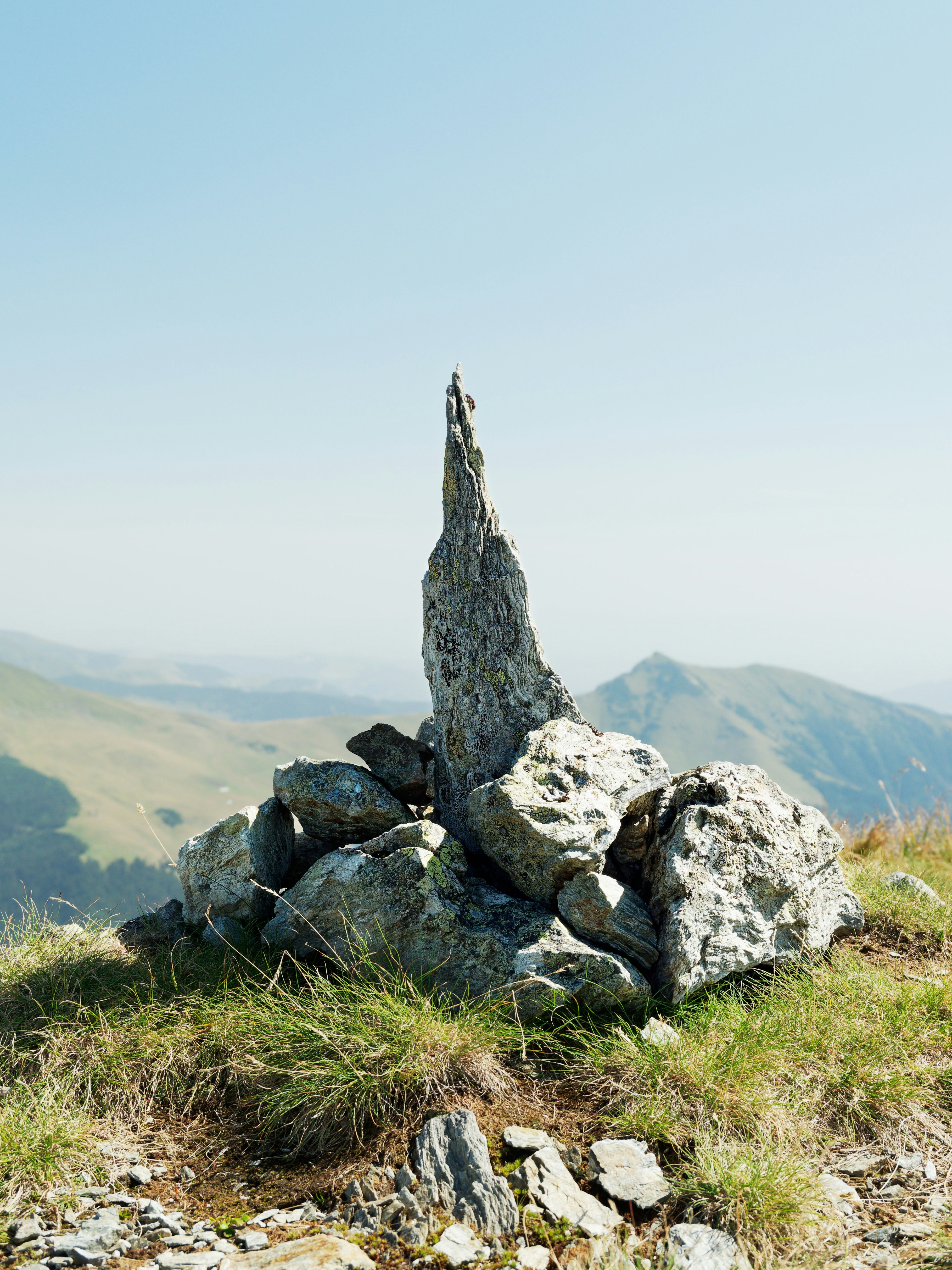 A stack of rocks on a grassy hill photo – Free Vârful laptelui mare ...