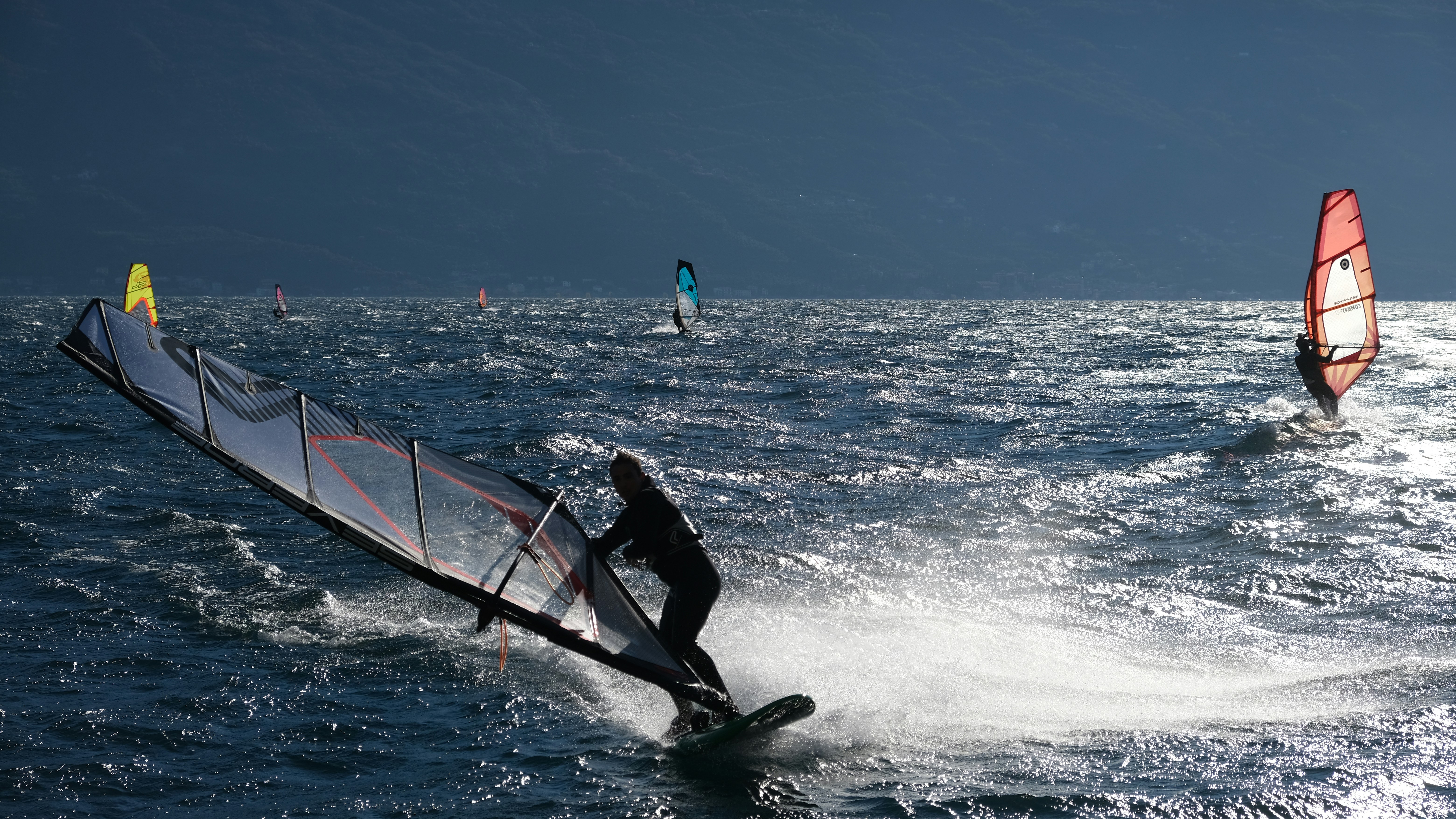 Crestcarver: Windsurfer Cutting Through Glinting Seas