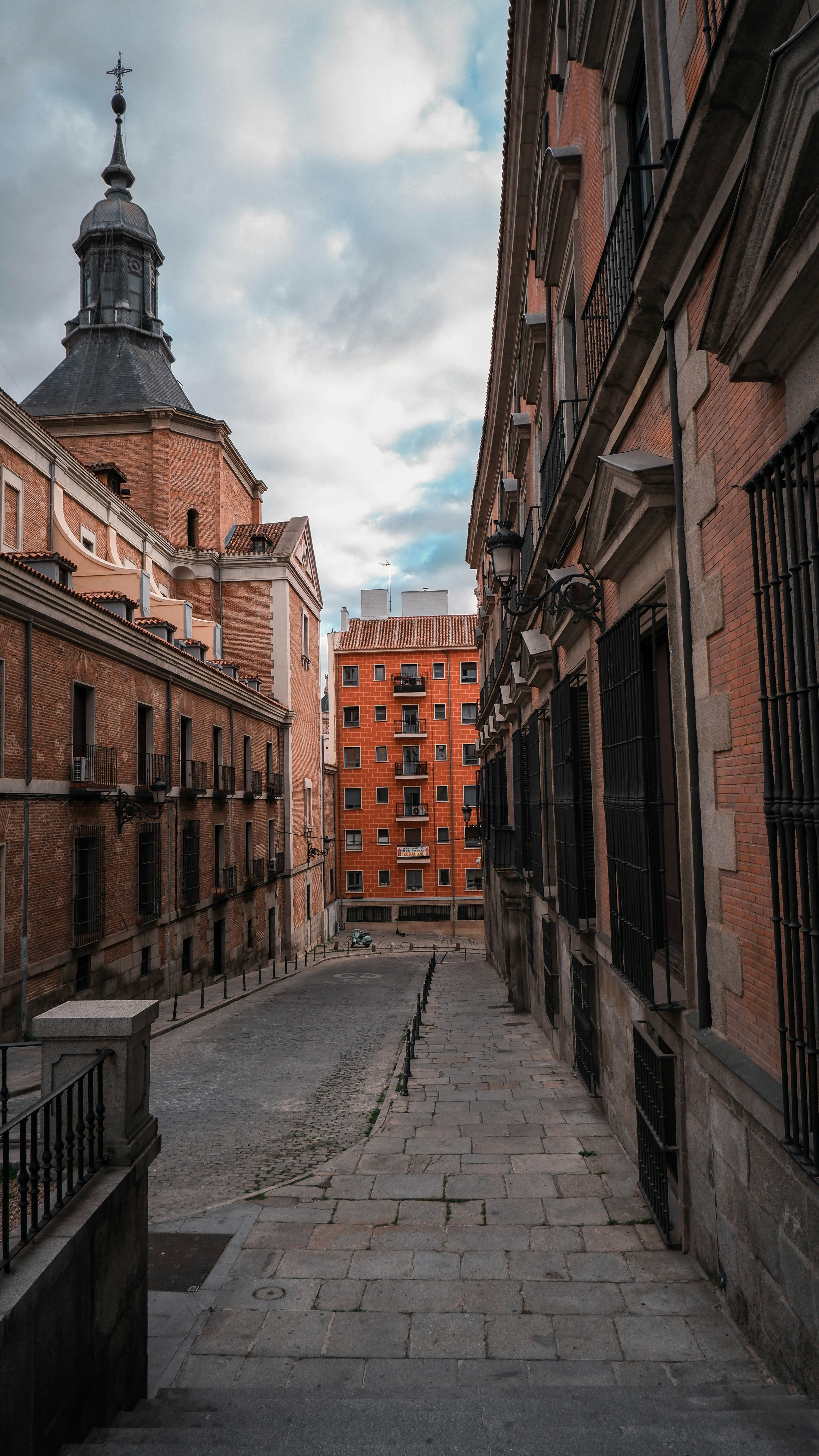 Alleyway to the City: Brick and Sky Between Towers