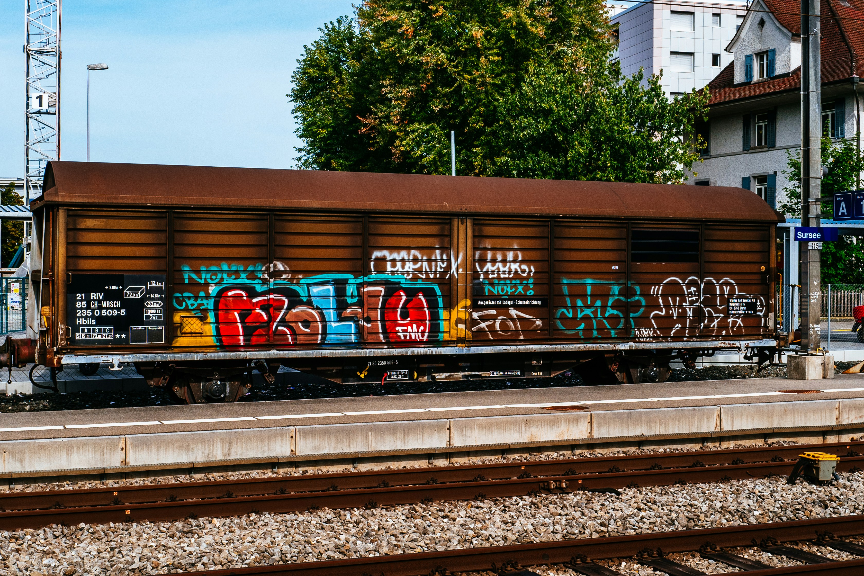 Graffiti-Laden Boxcar Anchors a Quiet Urban Platform