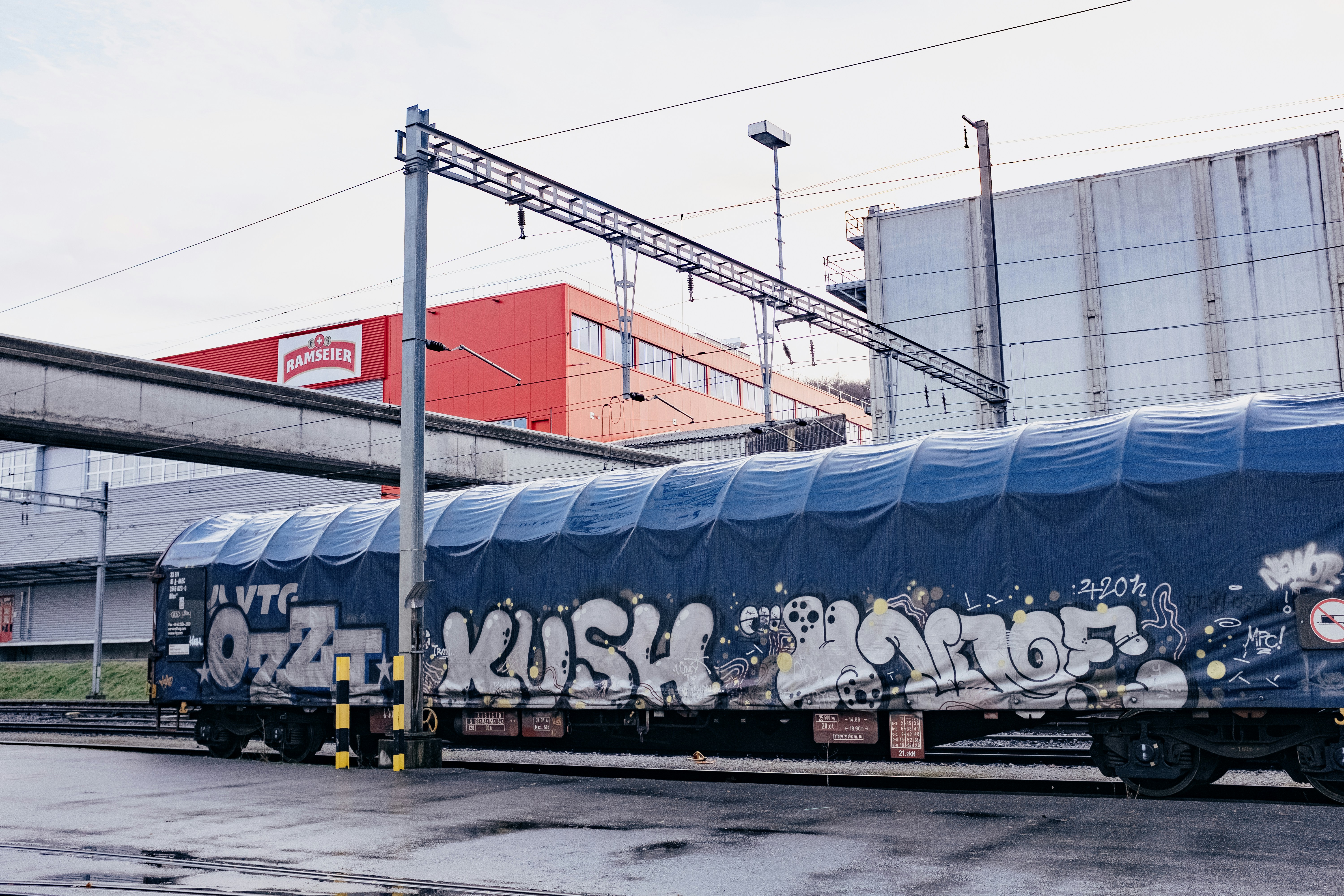 Graffiti-Splashed Freight Car Under Industrial Canopy