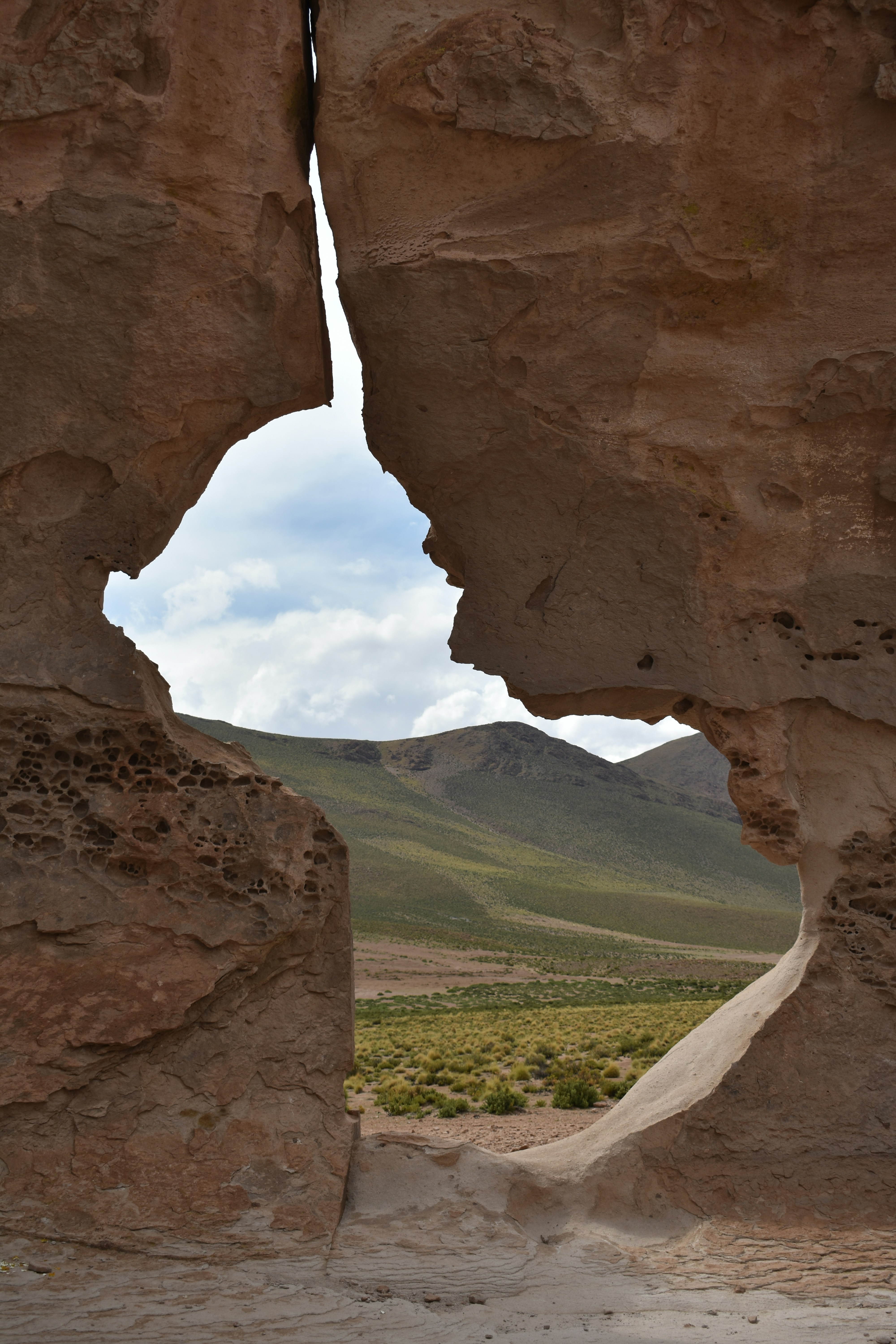A view of a valley through a rock archway photo – Free Altiplano Image ...