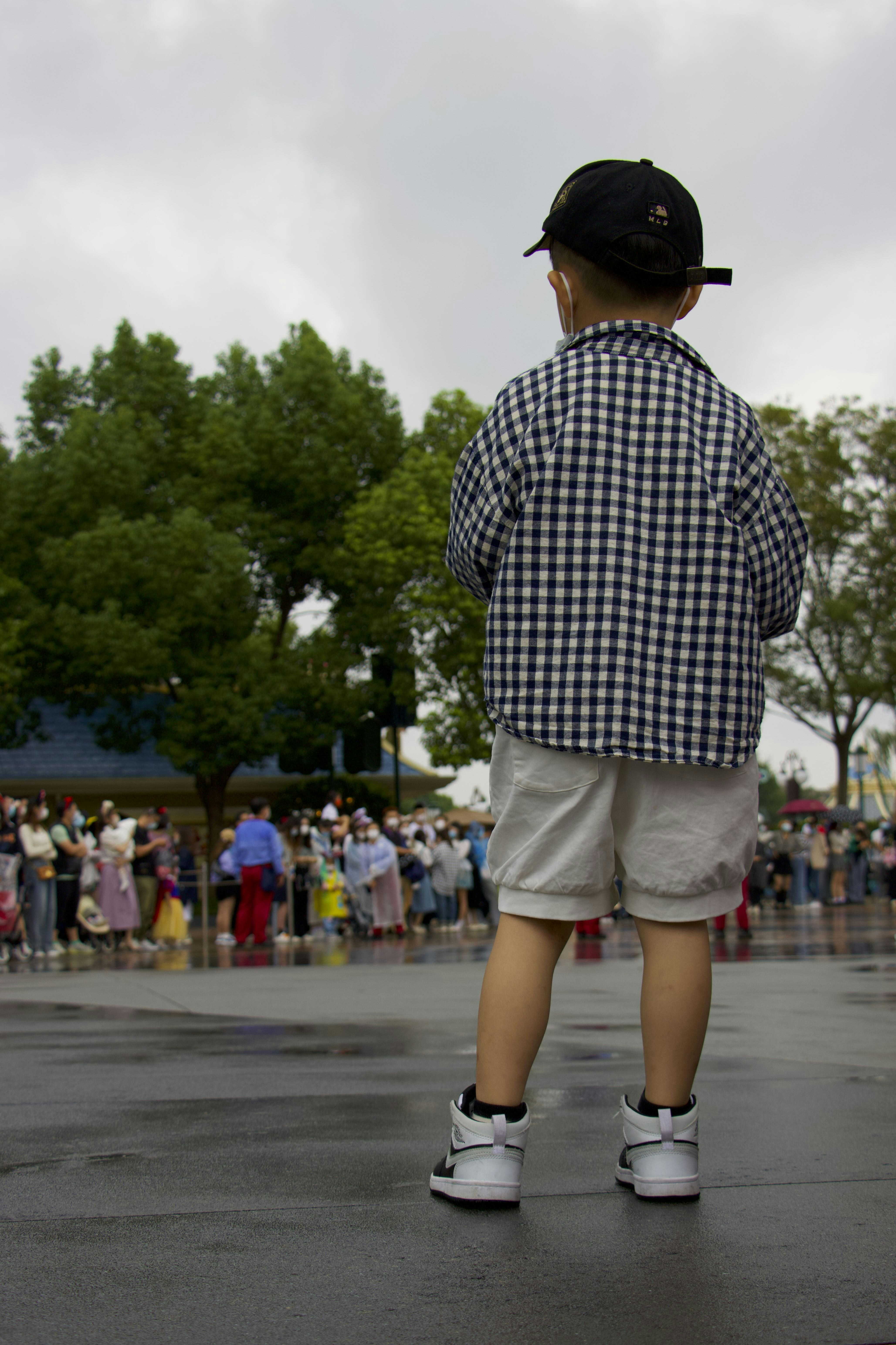 Back-View Observer in a Checkered Jacket Over a Crowded Square