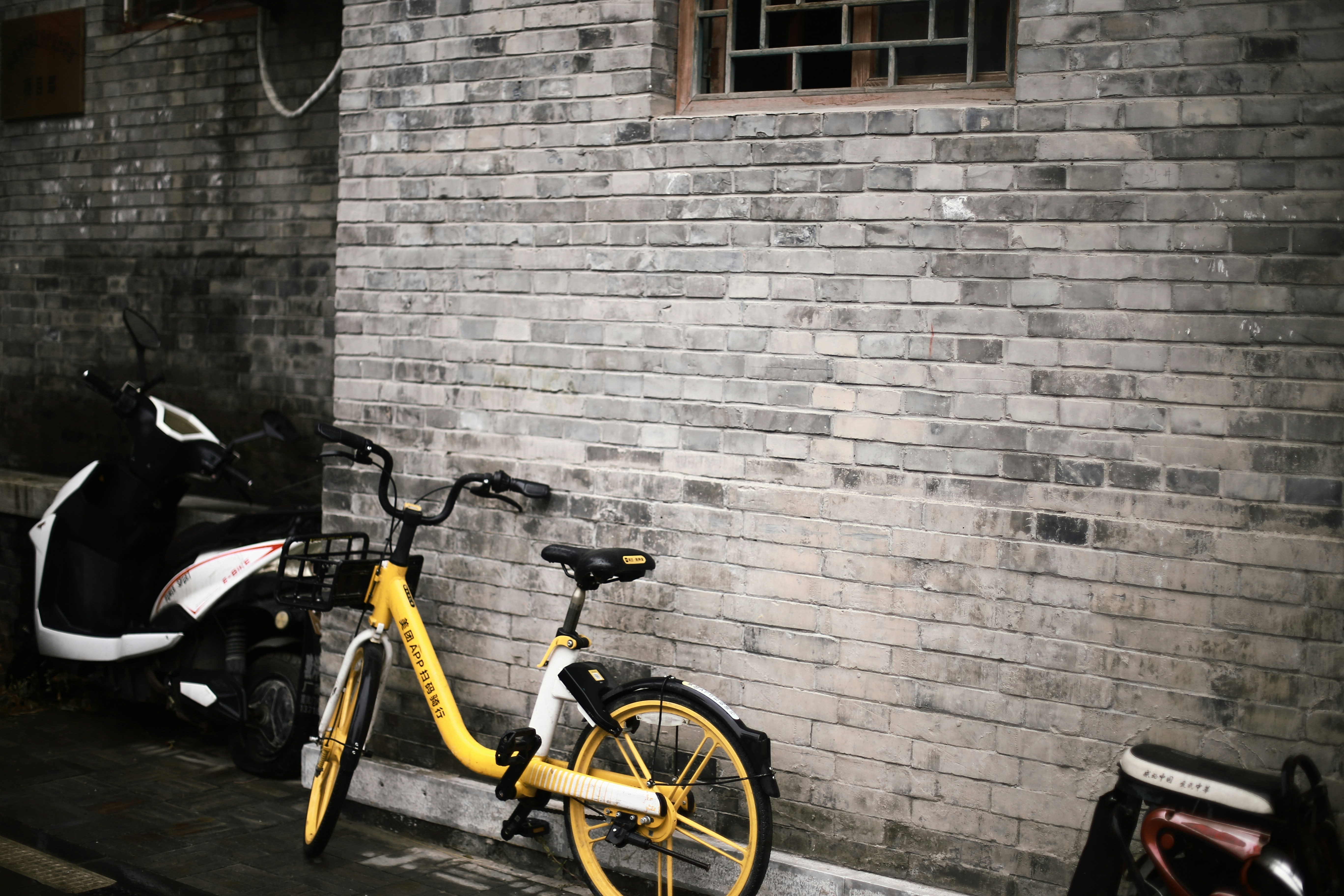 Bright Yellow City Bike Framed by Weathered Brick Wall