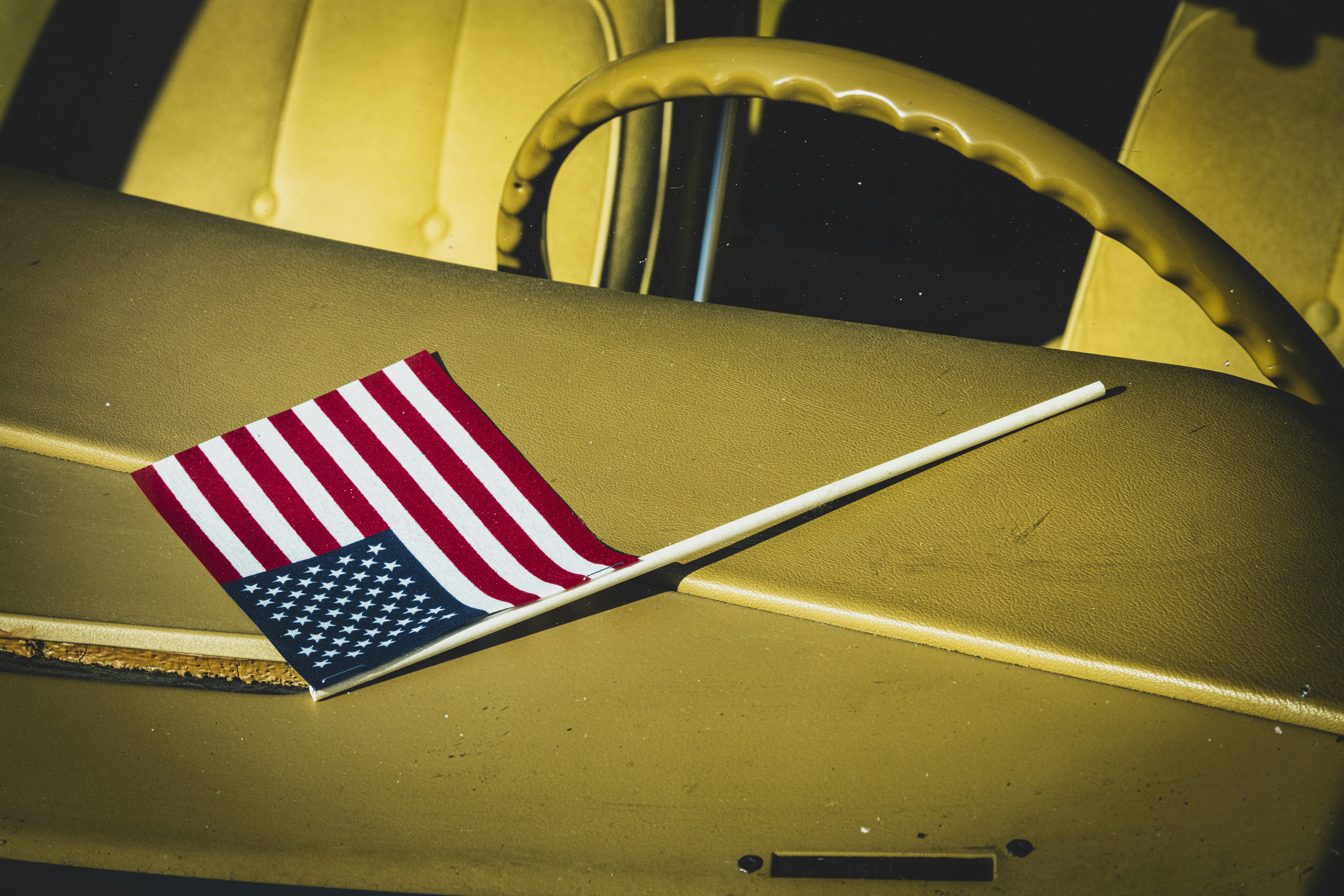 American Flag on a Sunlit Vintage Dash