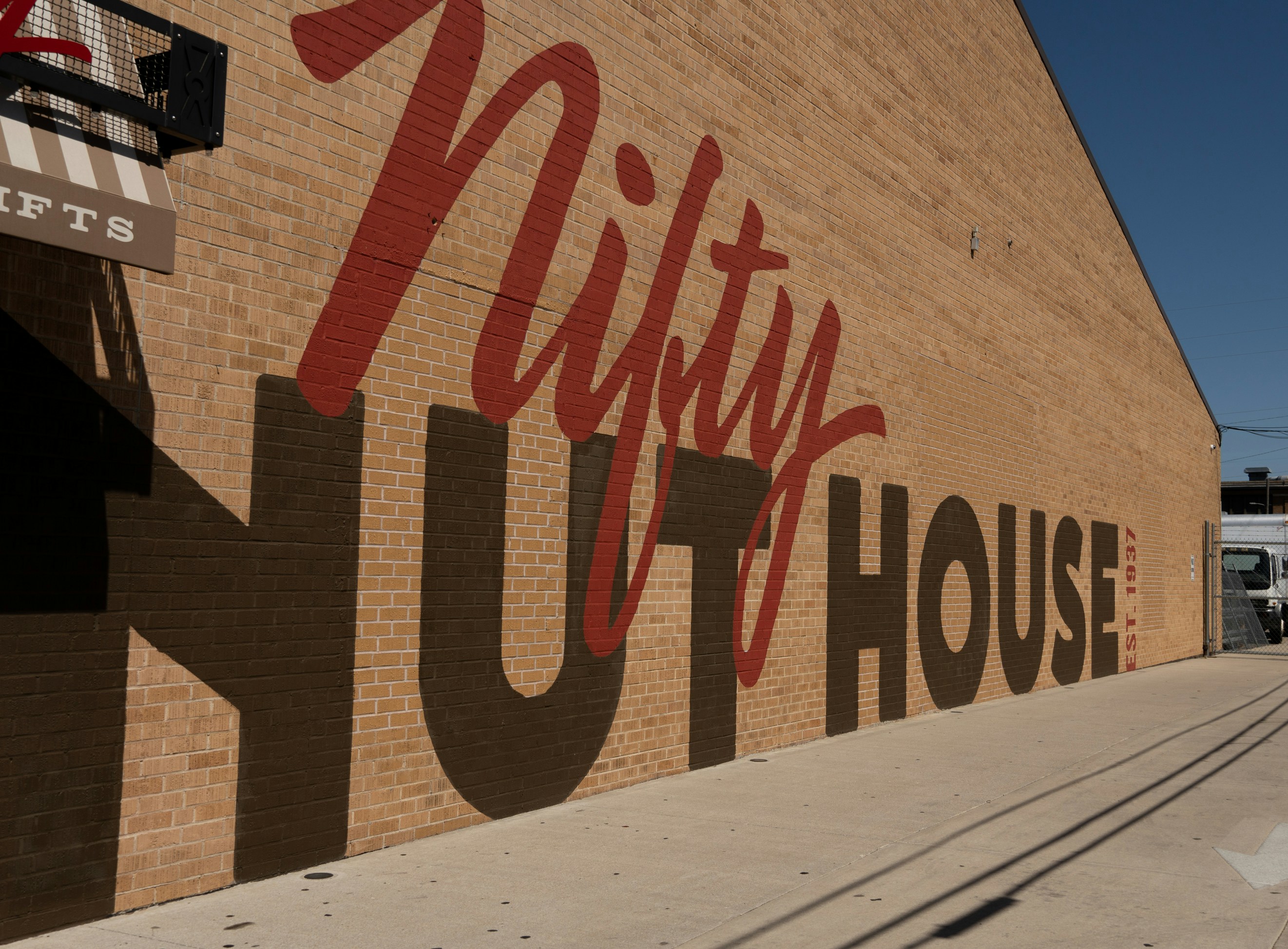 a brick wall with a red sign