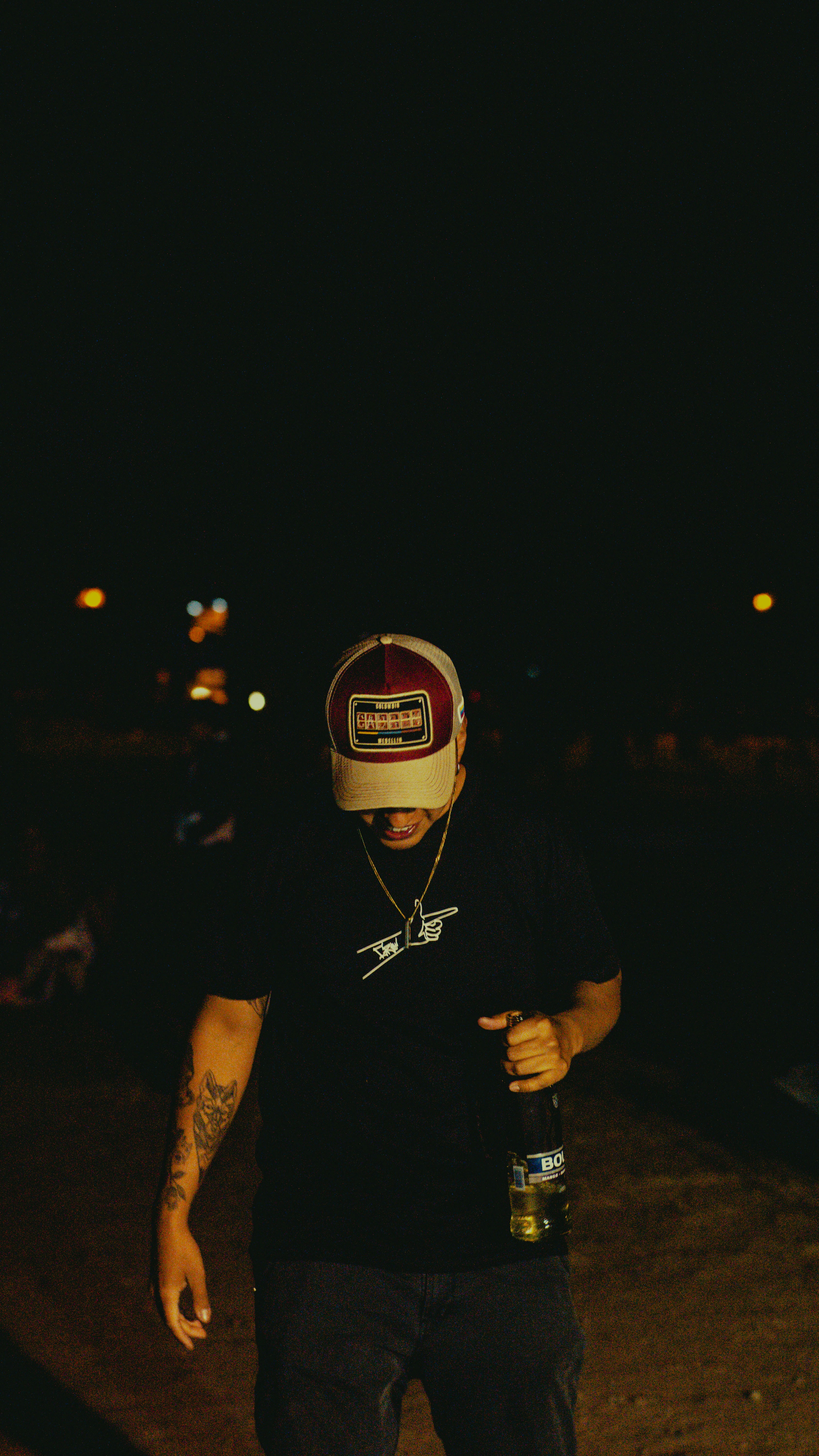 A man wearing a mask and holding a bottle of alcohol photo – Free Rap ...