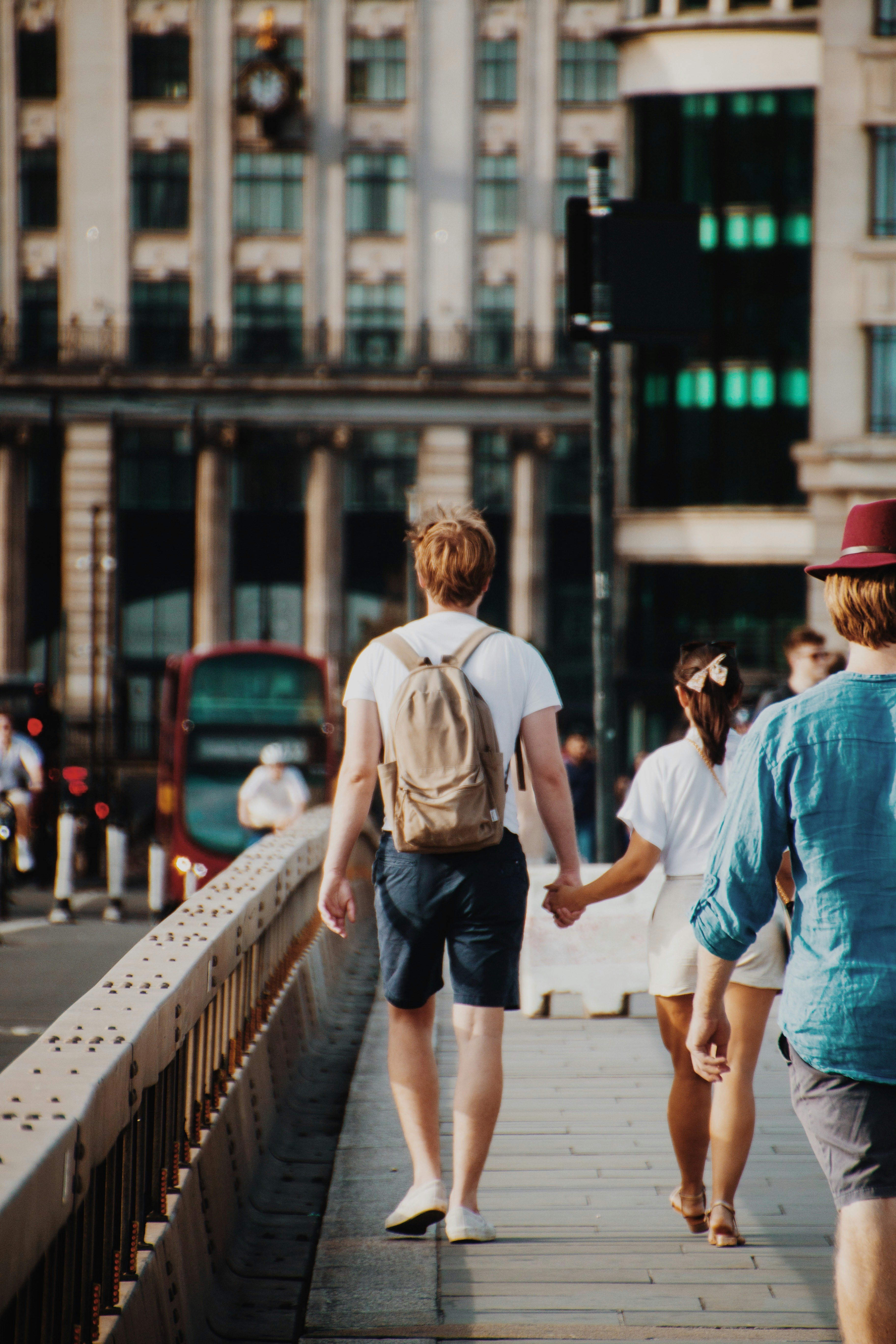 A group of people walking on a sidewalk photo – Free London Image on ...