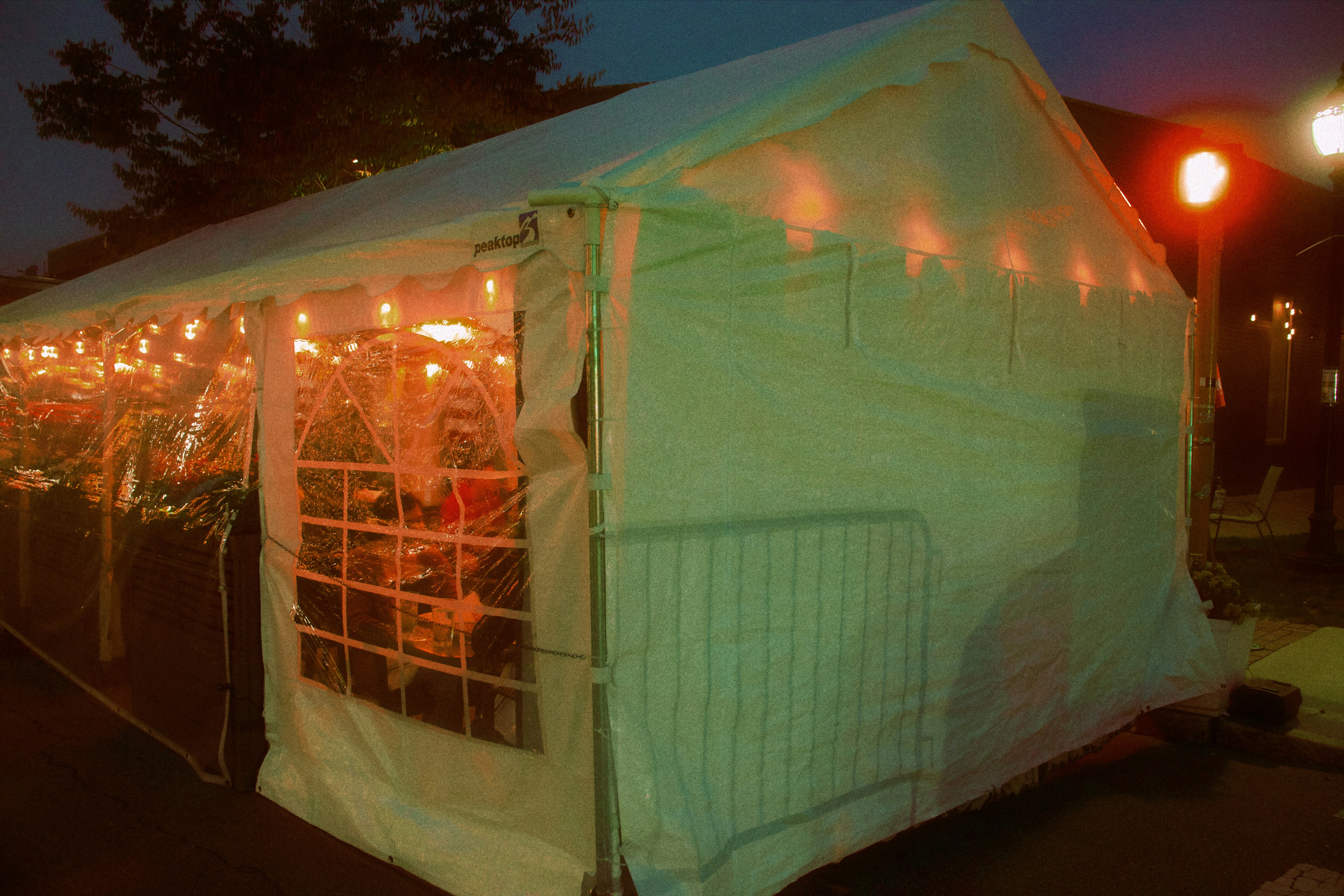 Warm glow over a white event tent at night
