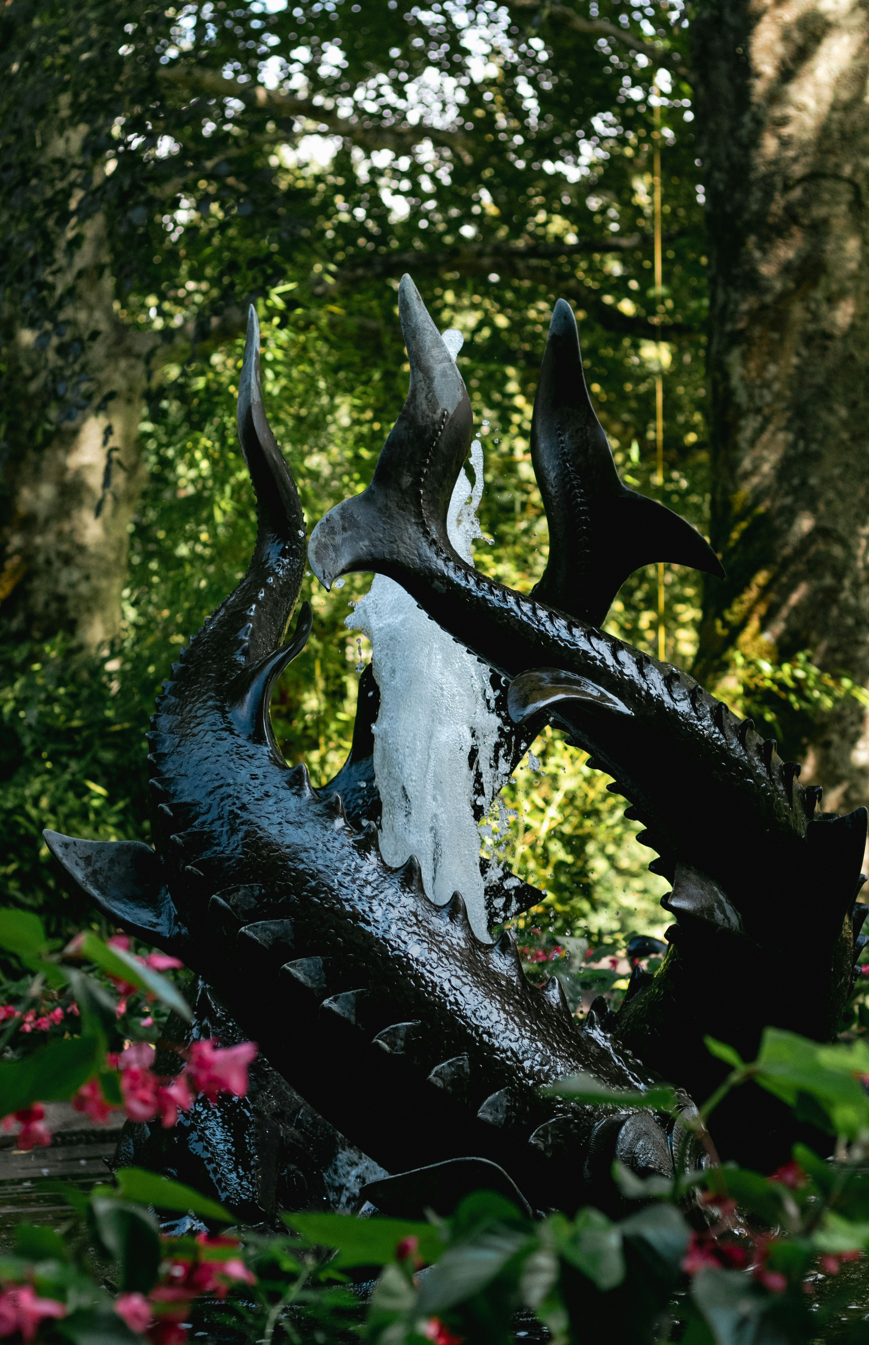 Garden Dragon Fountain: Gleaming Metal Serpent Amid Emerald Calm