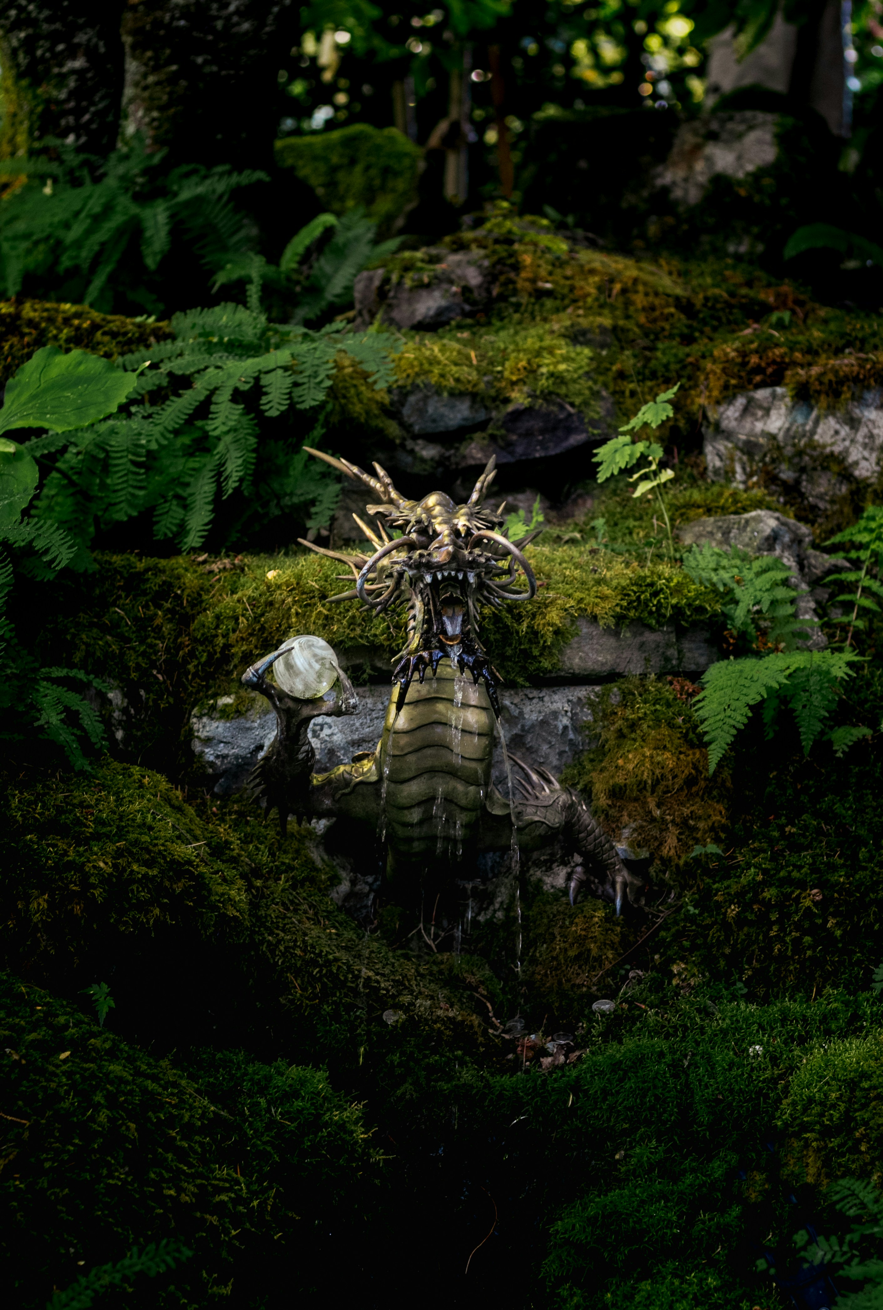 a statue of a deer in a forest