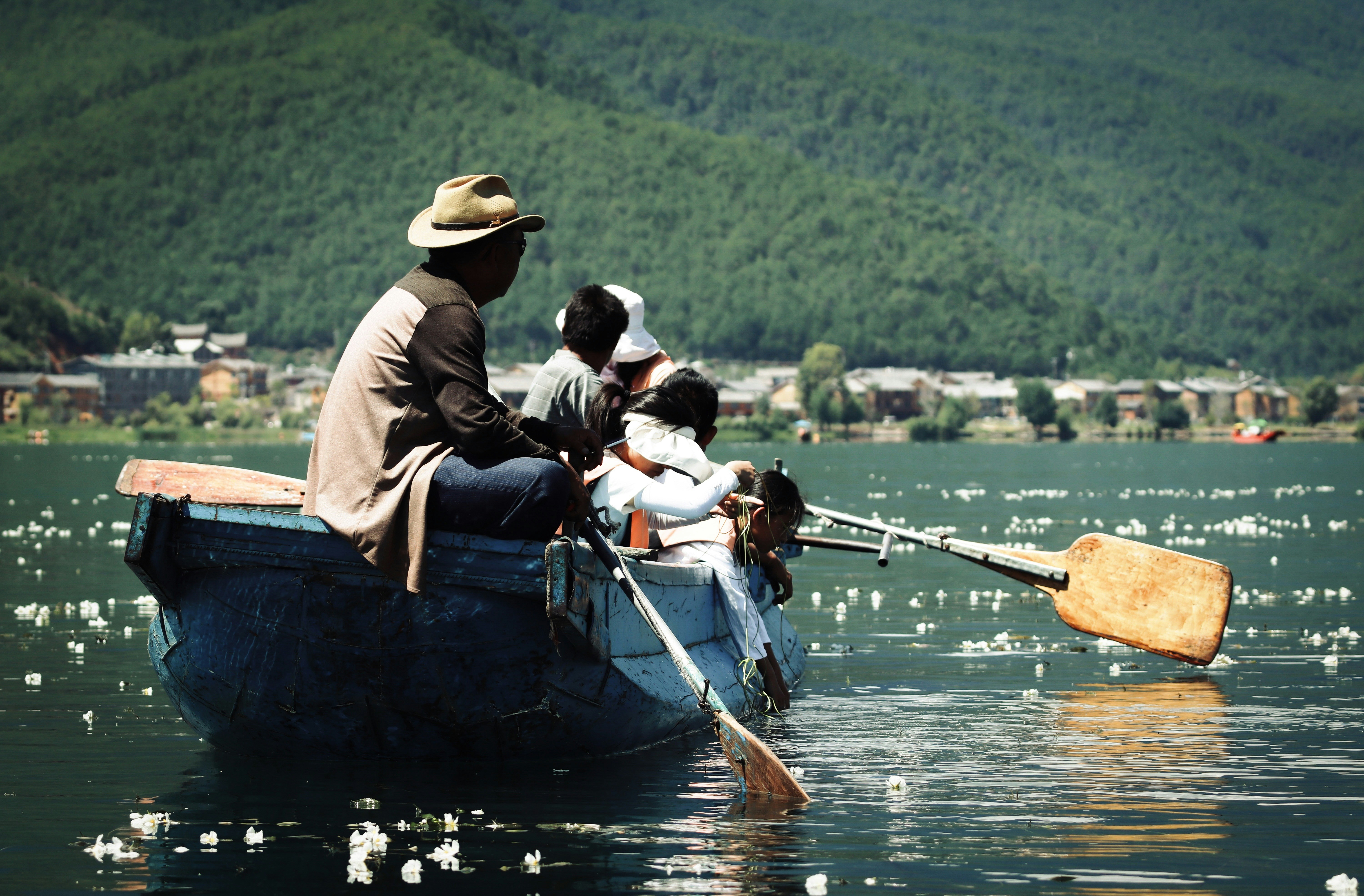 Echoes of a Paddle: a Quiet Boat Ride Against a Green Mountain Backdrop
