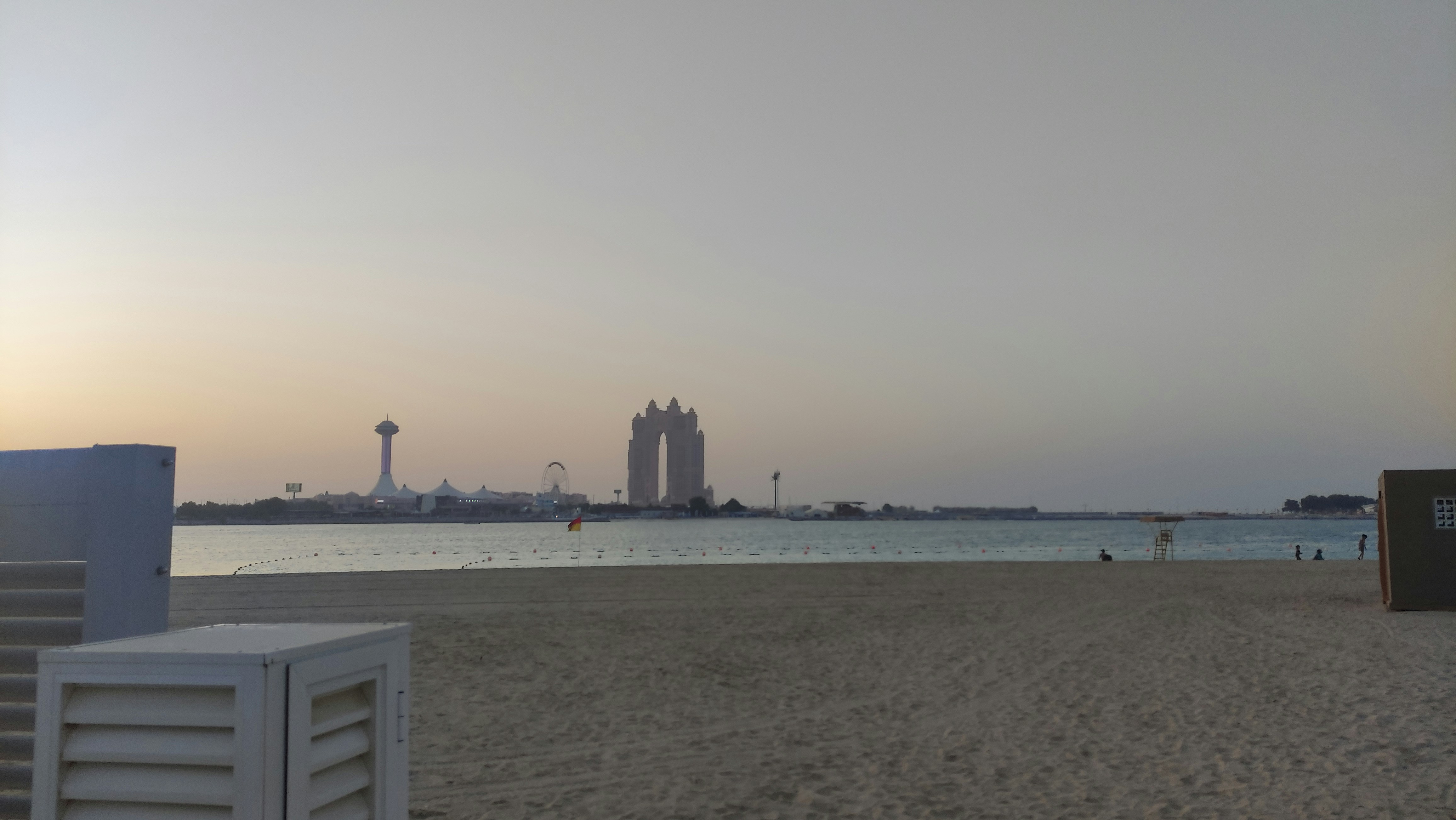 A beach with a lighthouse in the distance photo – Free Abu dhabi ...