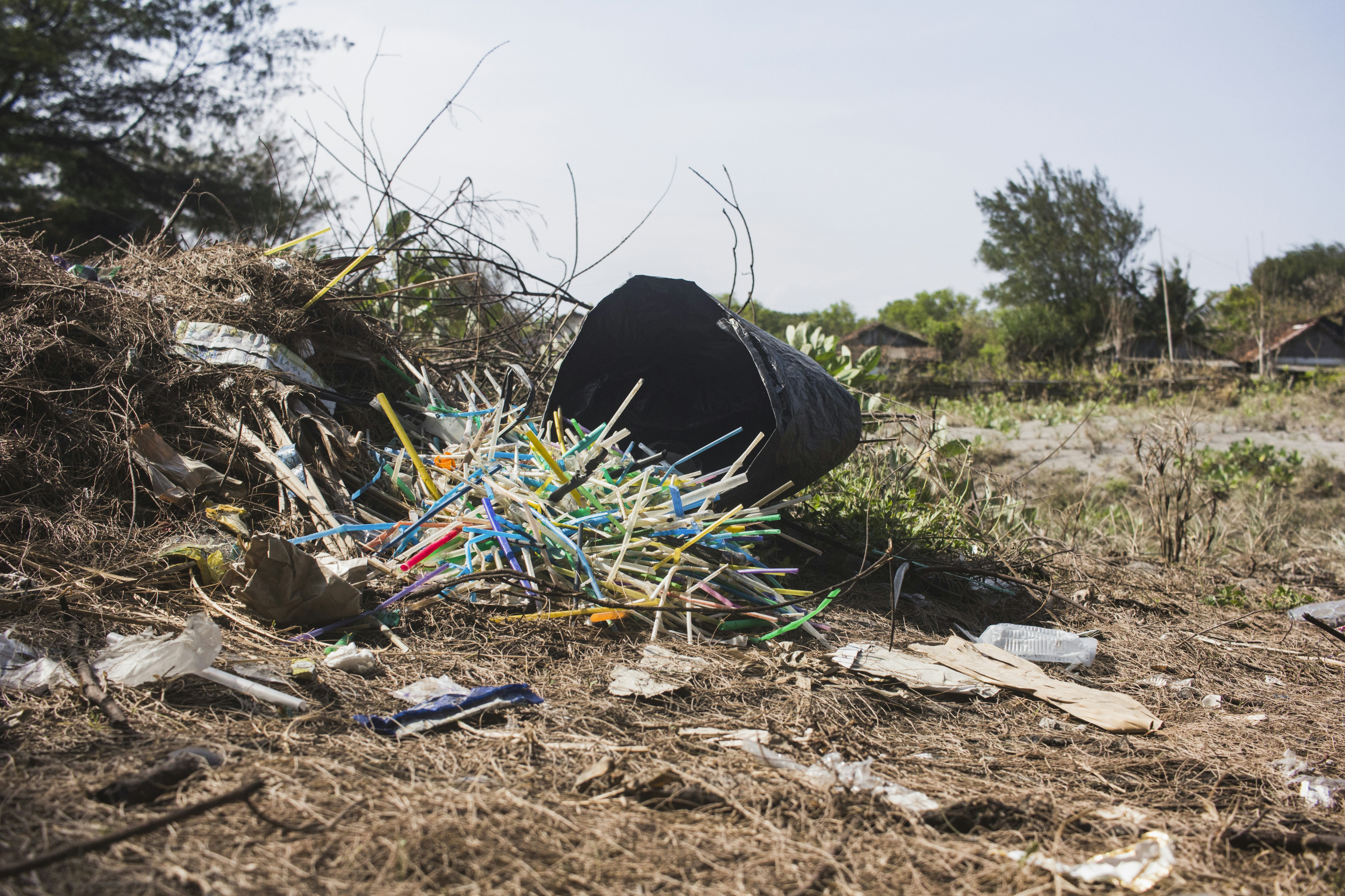 A pile of garbage in a field photo – Free Pantai pelangi Image on Unsplash