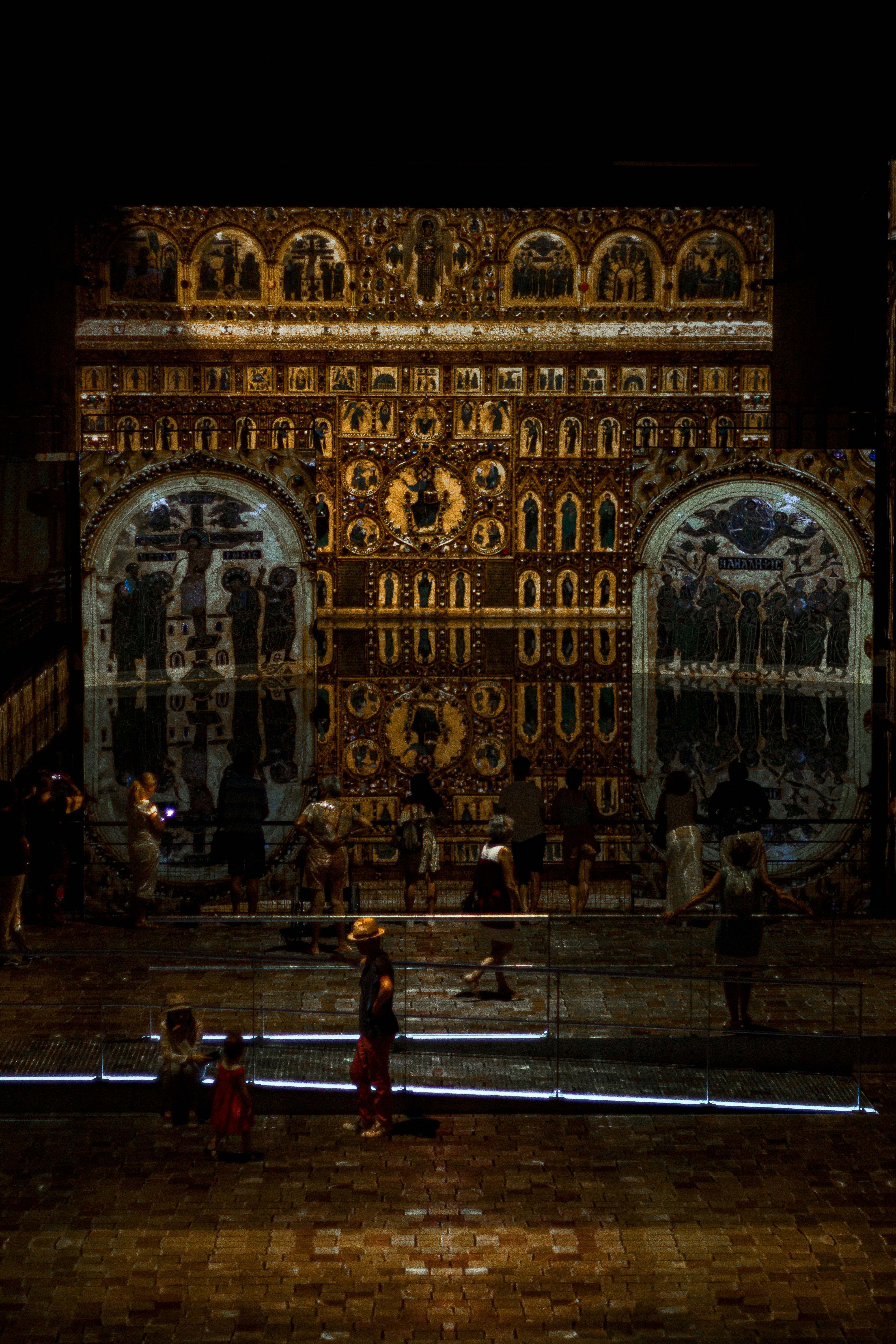 A group of people in front of a building with many arches photo – Free ...