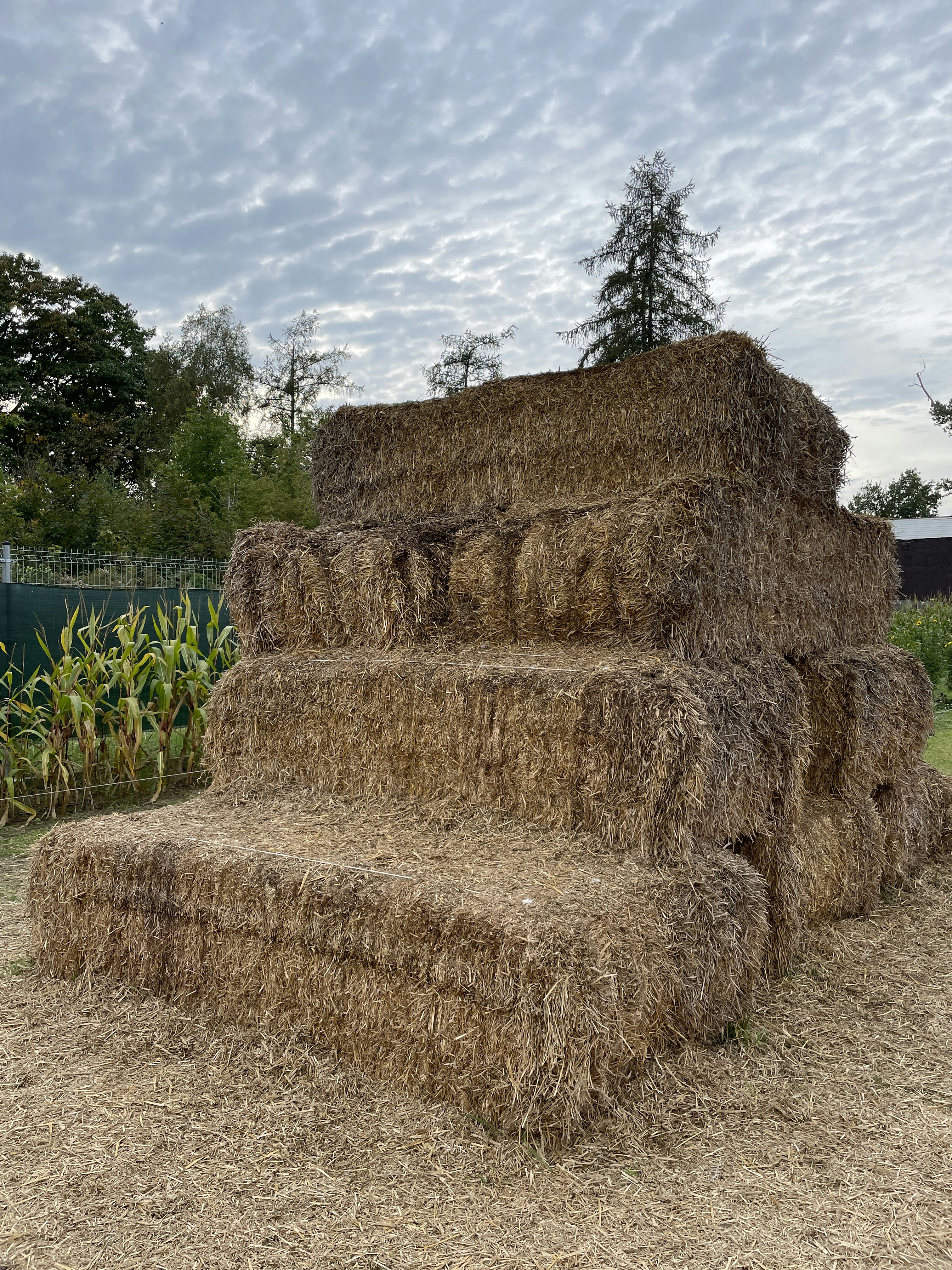 Tiered Hay Bale Stack under a Quiet Farmyard Sky
