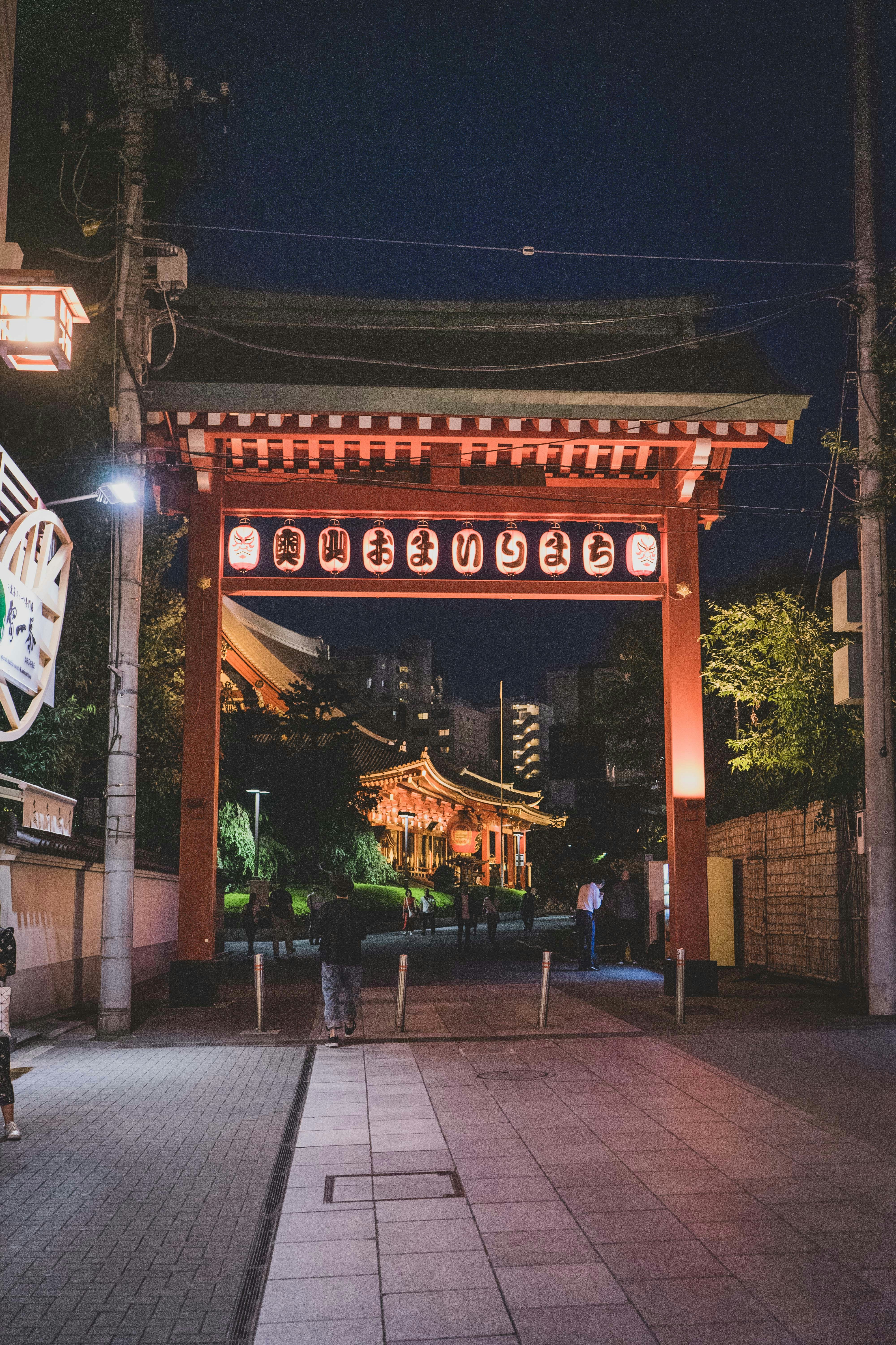 Lantern-lit Torii at Night: A Quiet Shrine Entrance on a Stone Street
