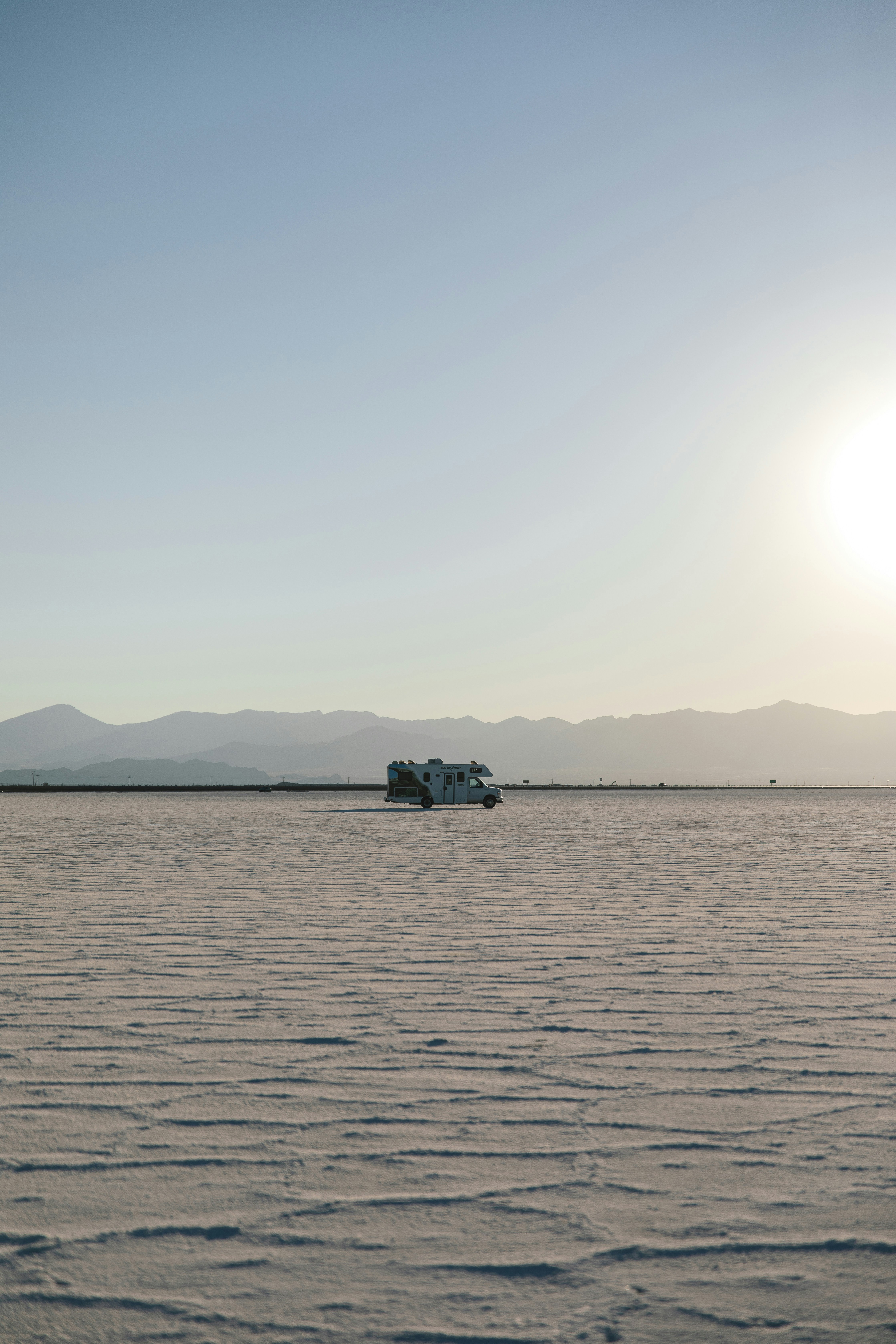 RV on a Salt Flat Under a Bleached Sky