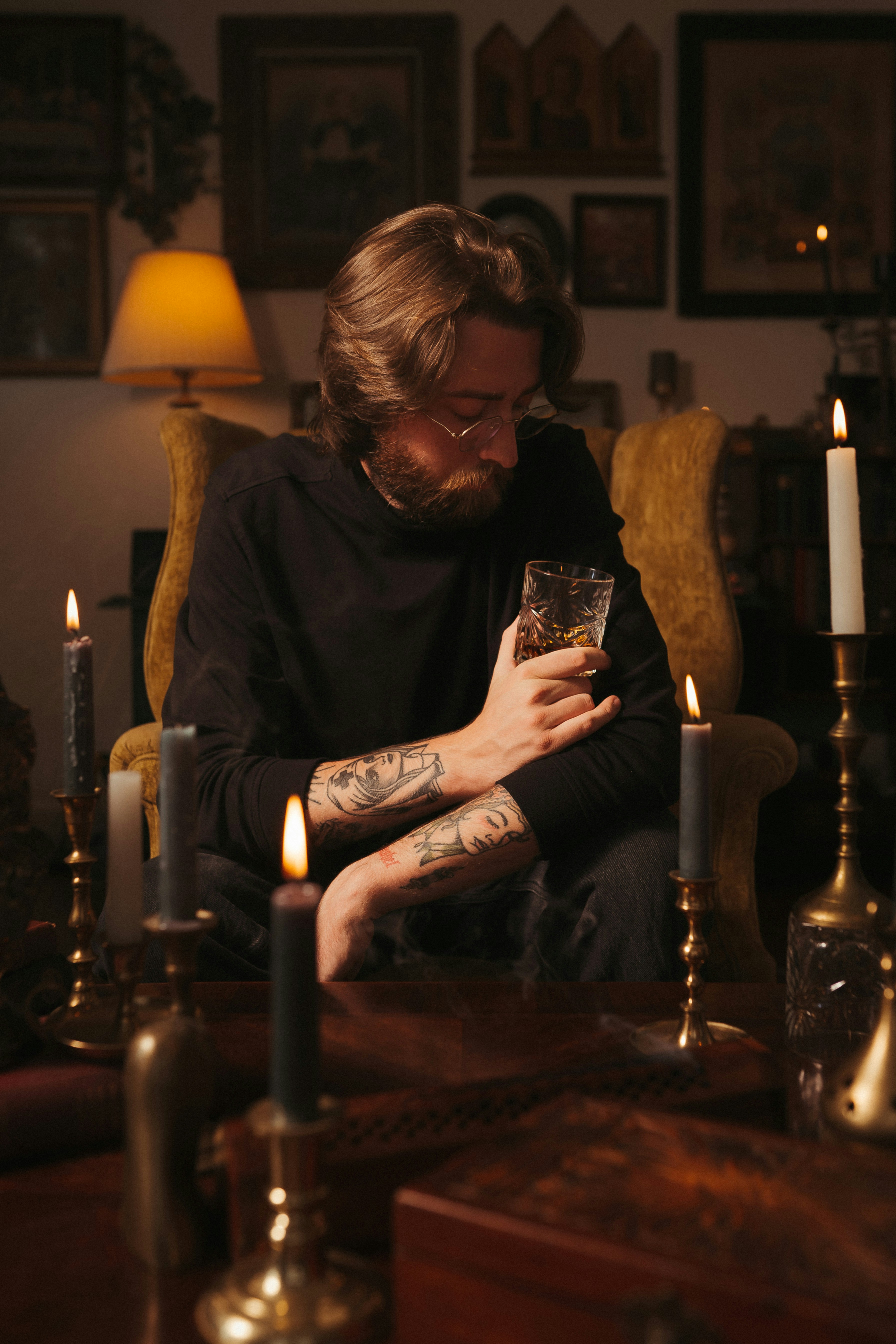 Candlelit Introspection: Inked Hands and a Glass
