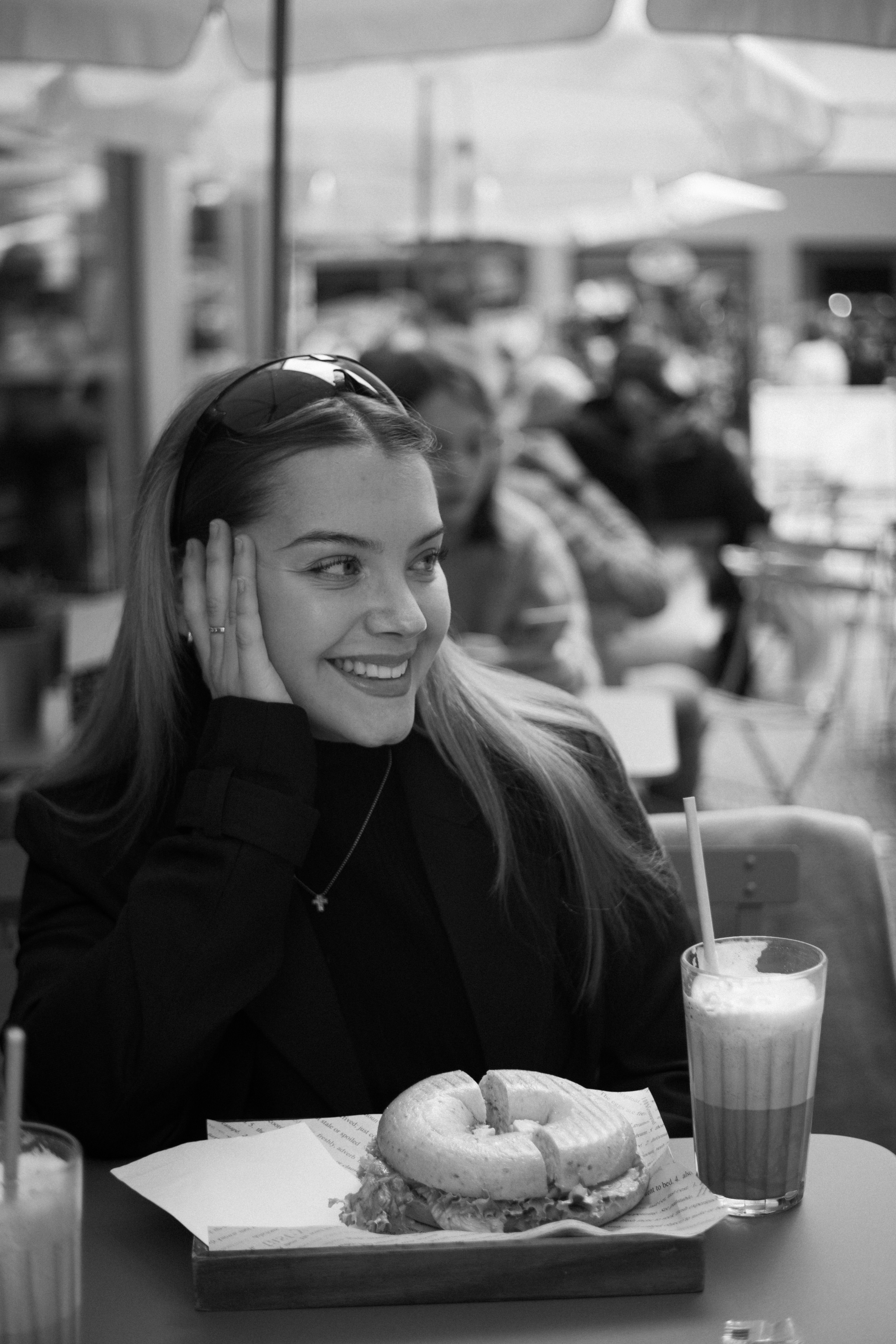 Cafe Portrait: A Quiet Smile Beneath Sunglasses