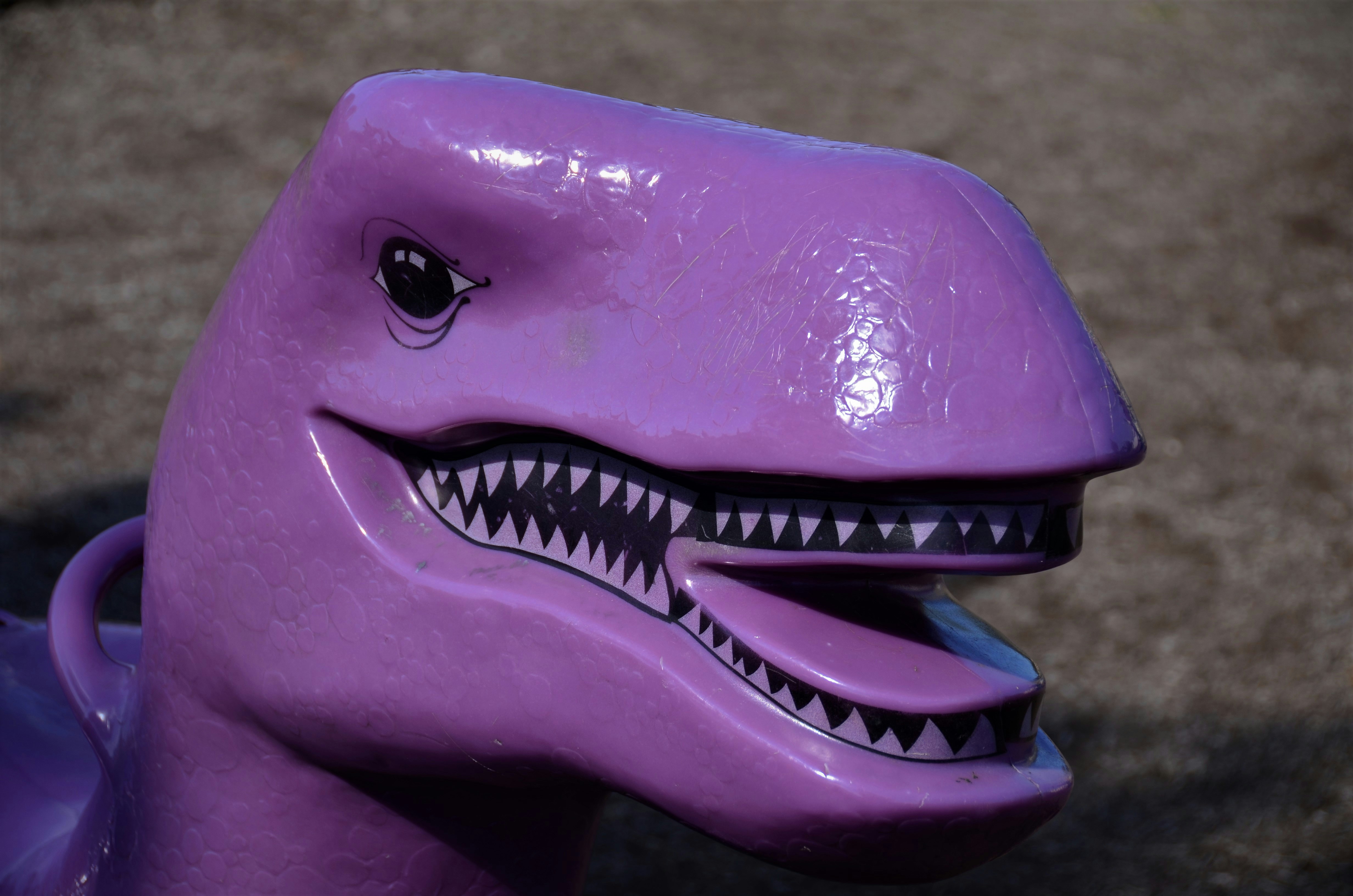 Glossy Purple Shark Head: A Playful Close-Up of Color and Teeth