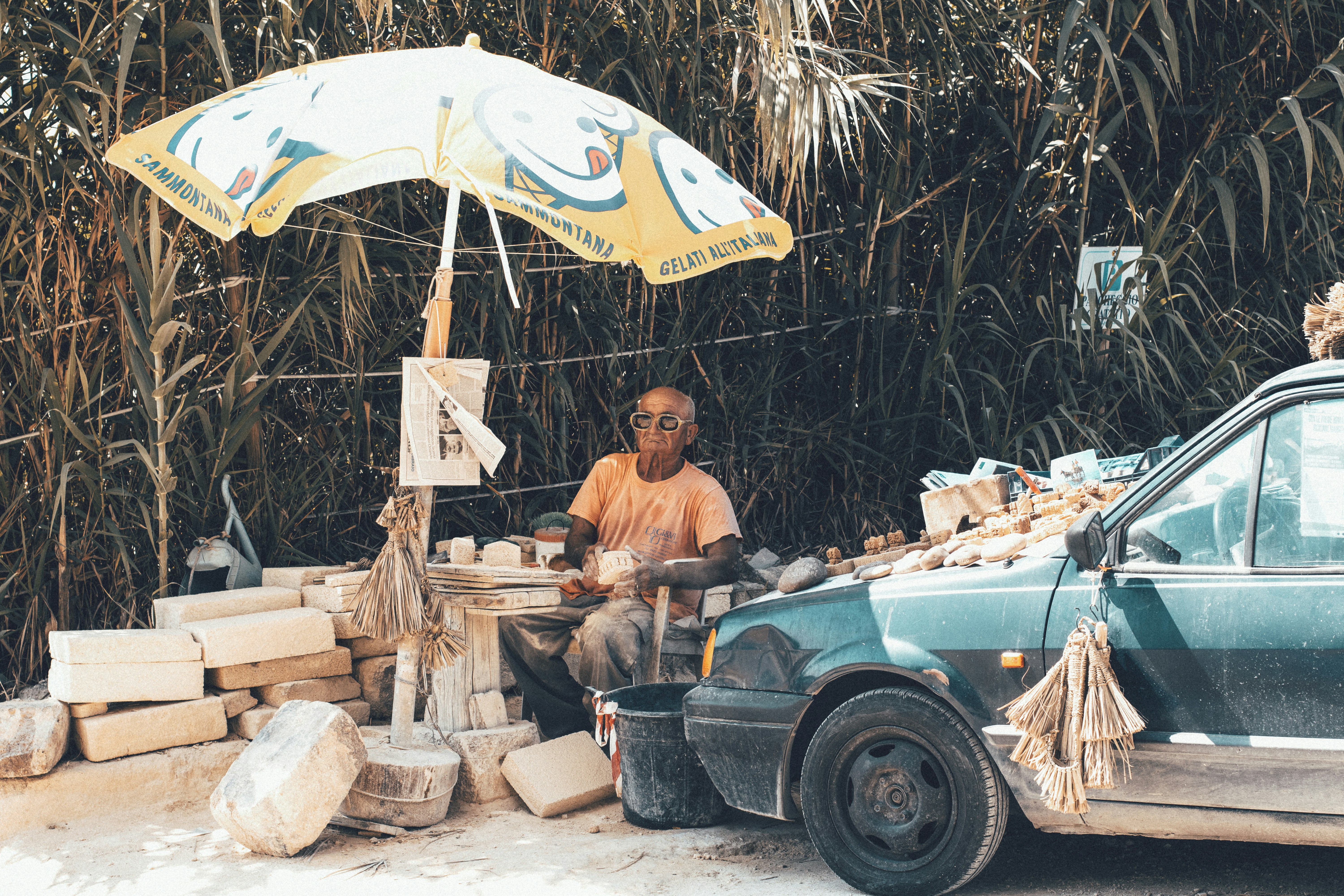 Standby Street Vendor under a Weathered Umbrella