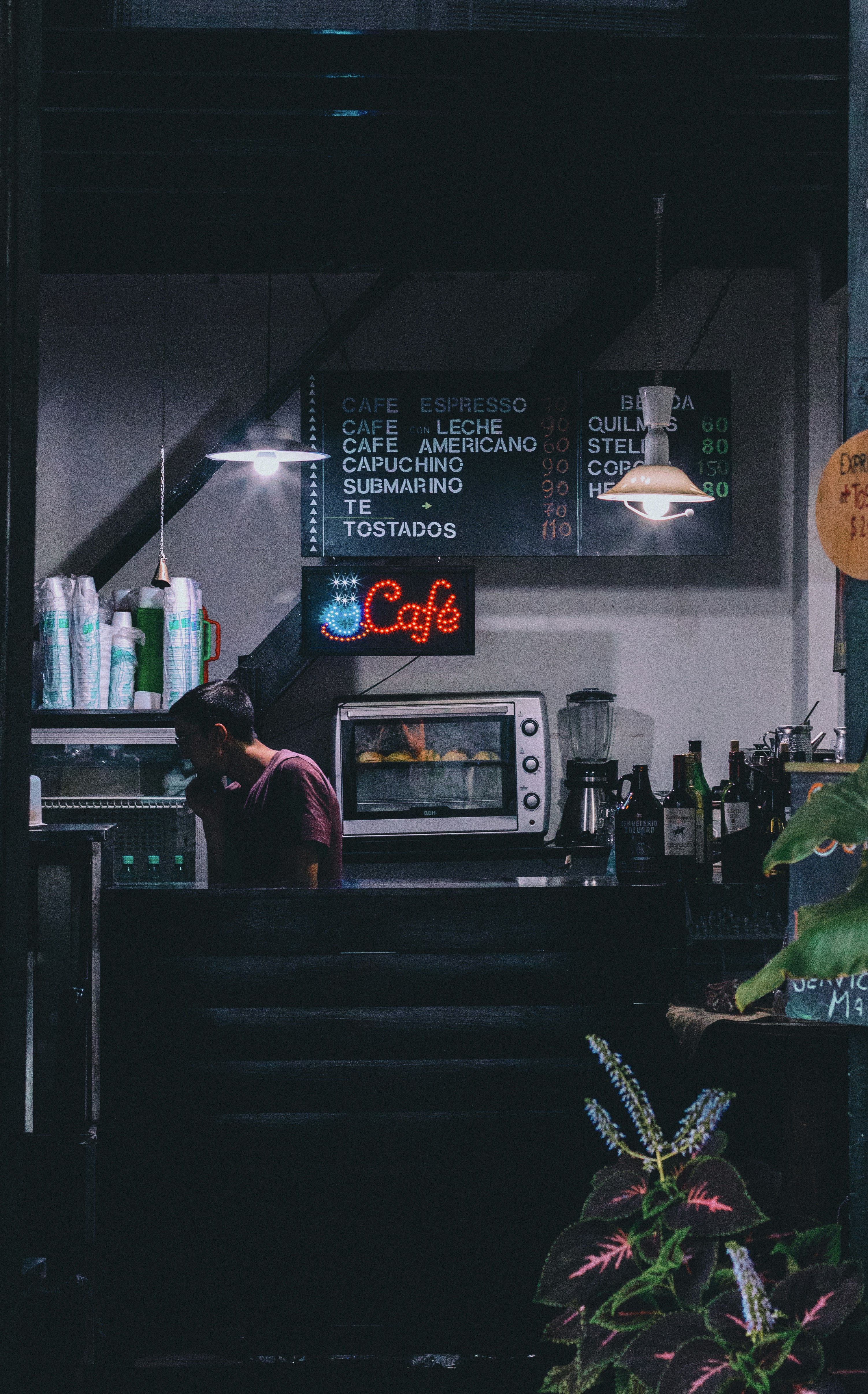 Una persona detrás de un mostrador con un letrero encima foto – Imagen ...