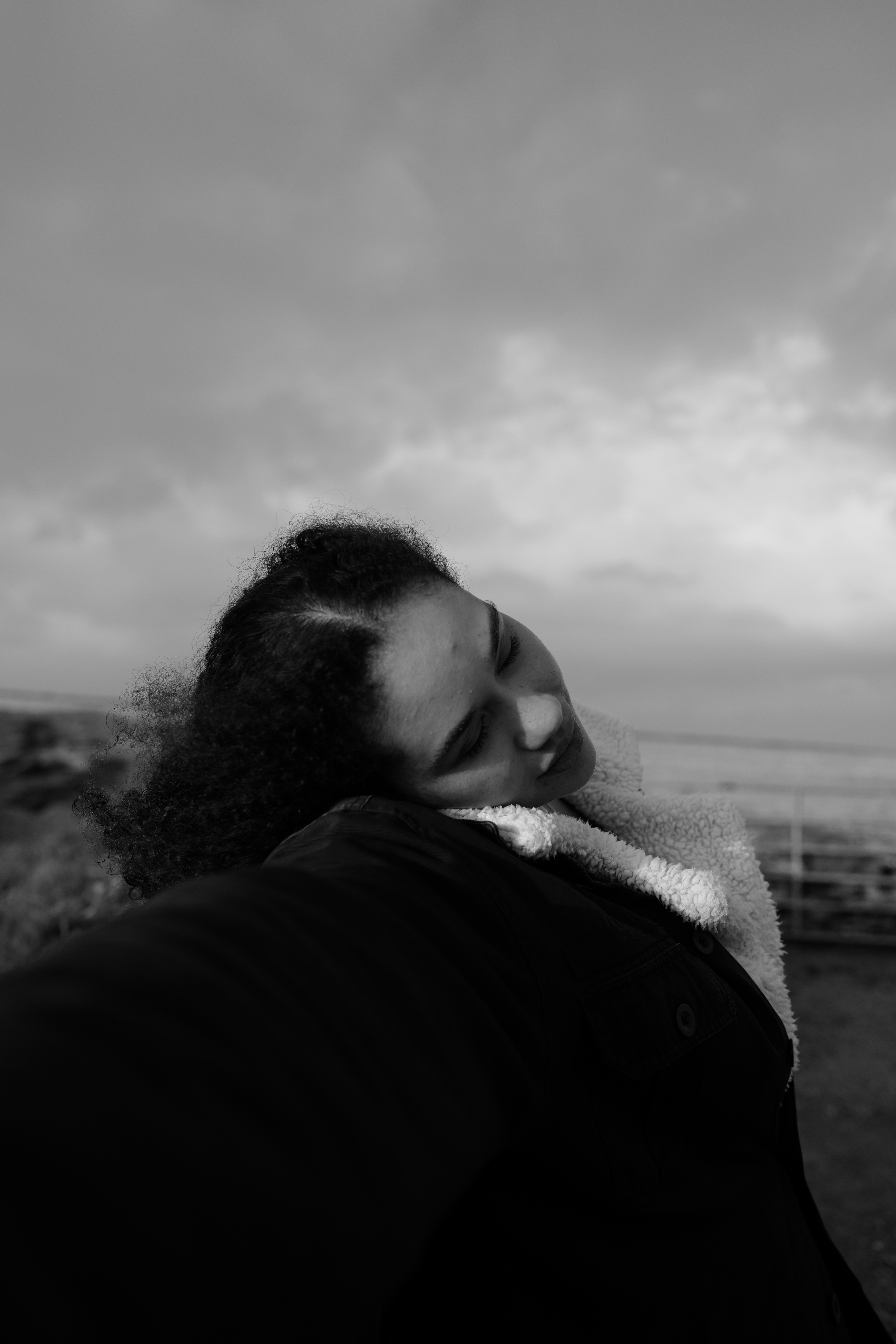 Tilted Portrait beneath a Brooding Sky by the Seawall