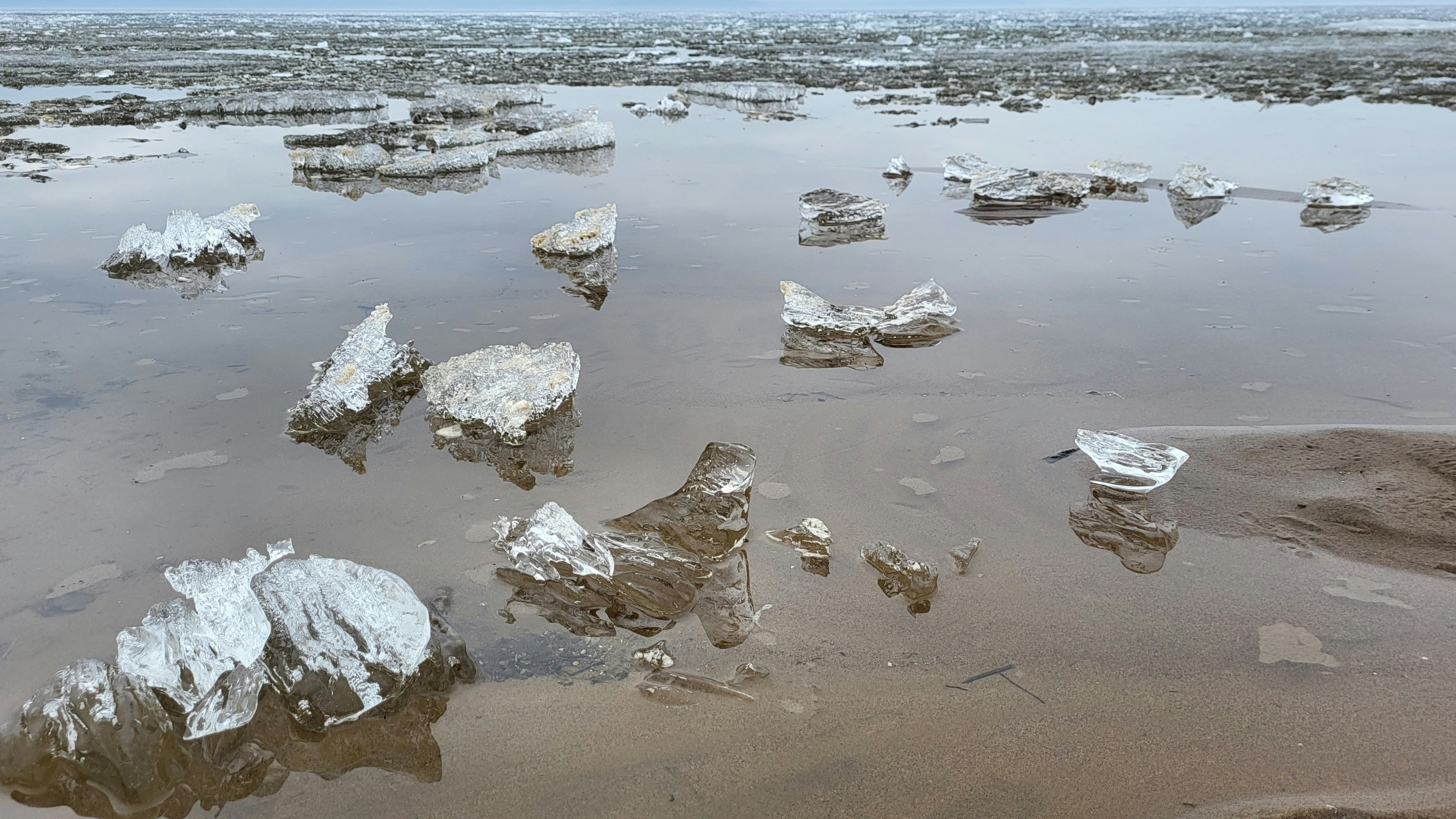Fragmented Ice Along a Tranquil Spring River