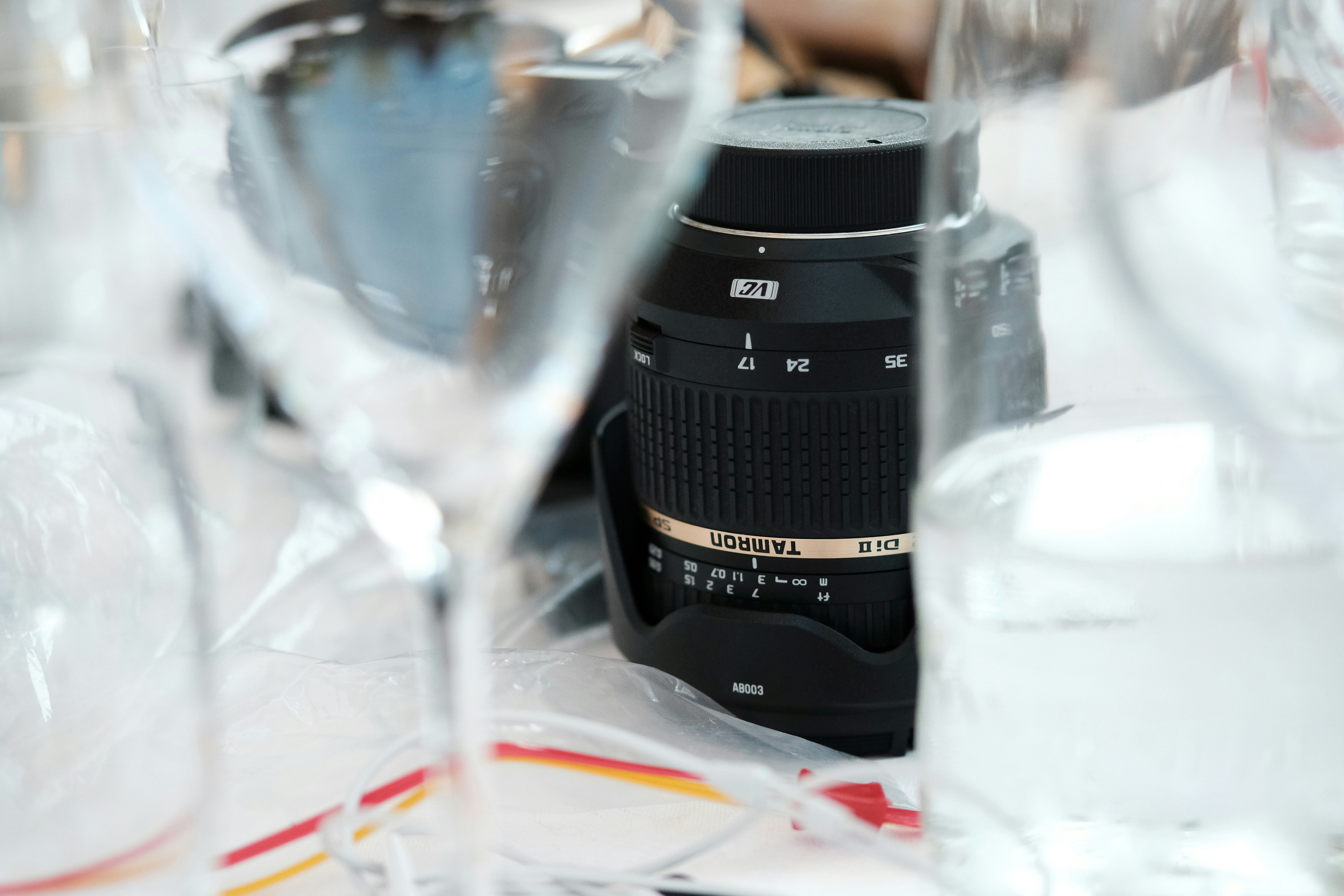 Tamron Lens Between Crystal Glasses: A Quiet Dinner Table Portrait