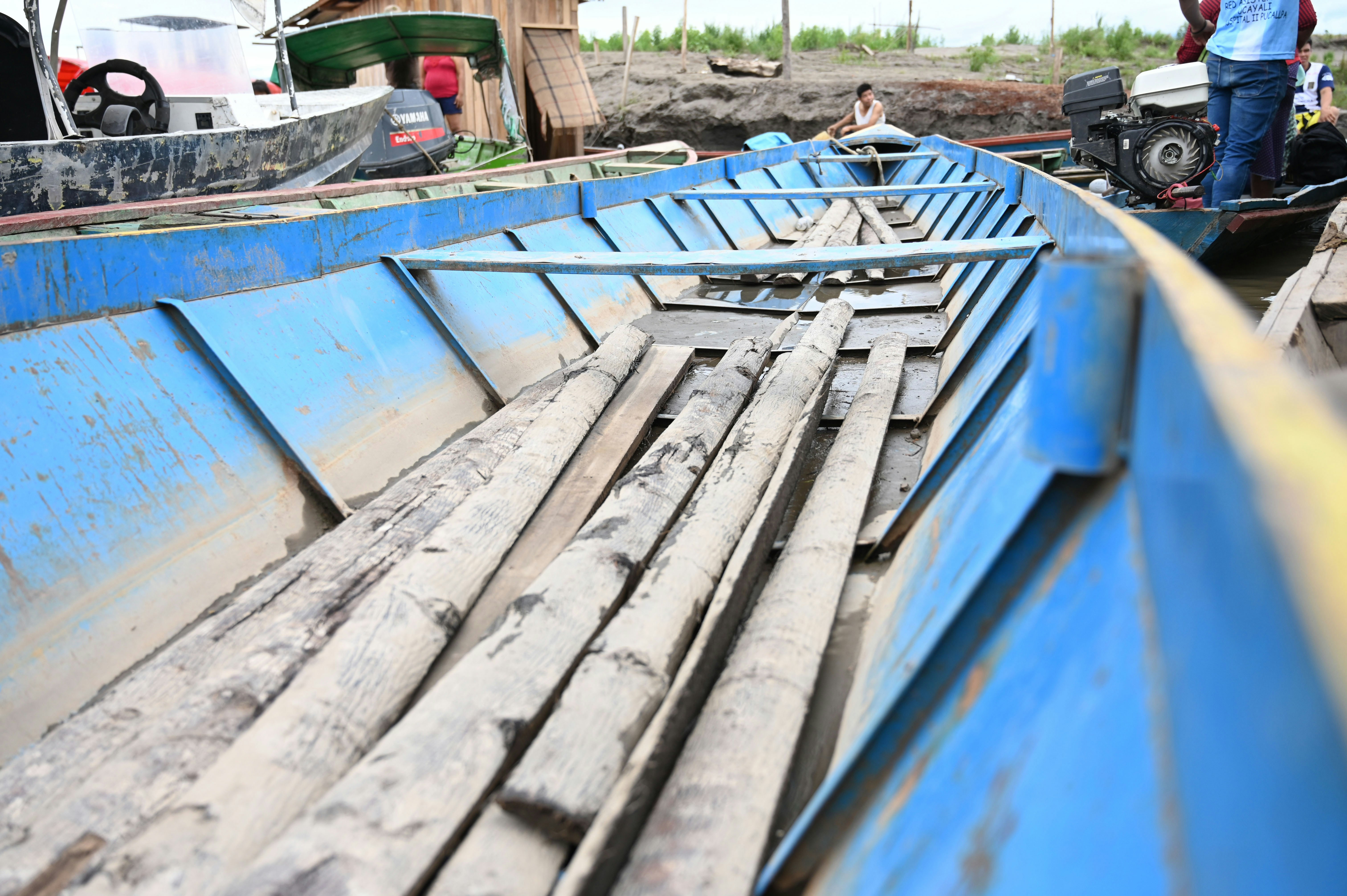 Weathered Blue Boat: Wooden Slats Stretching Toward the Shore