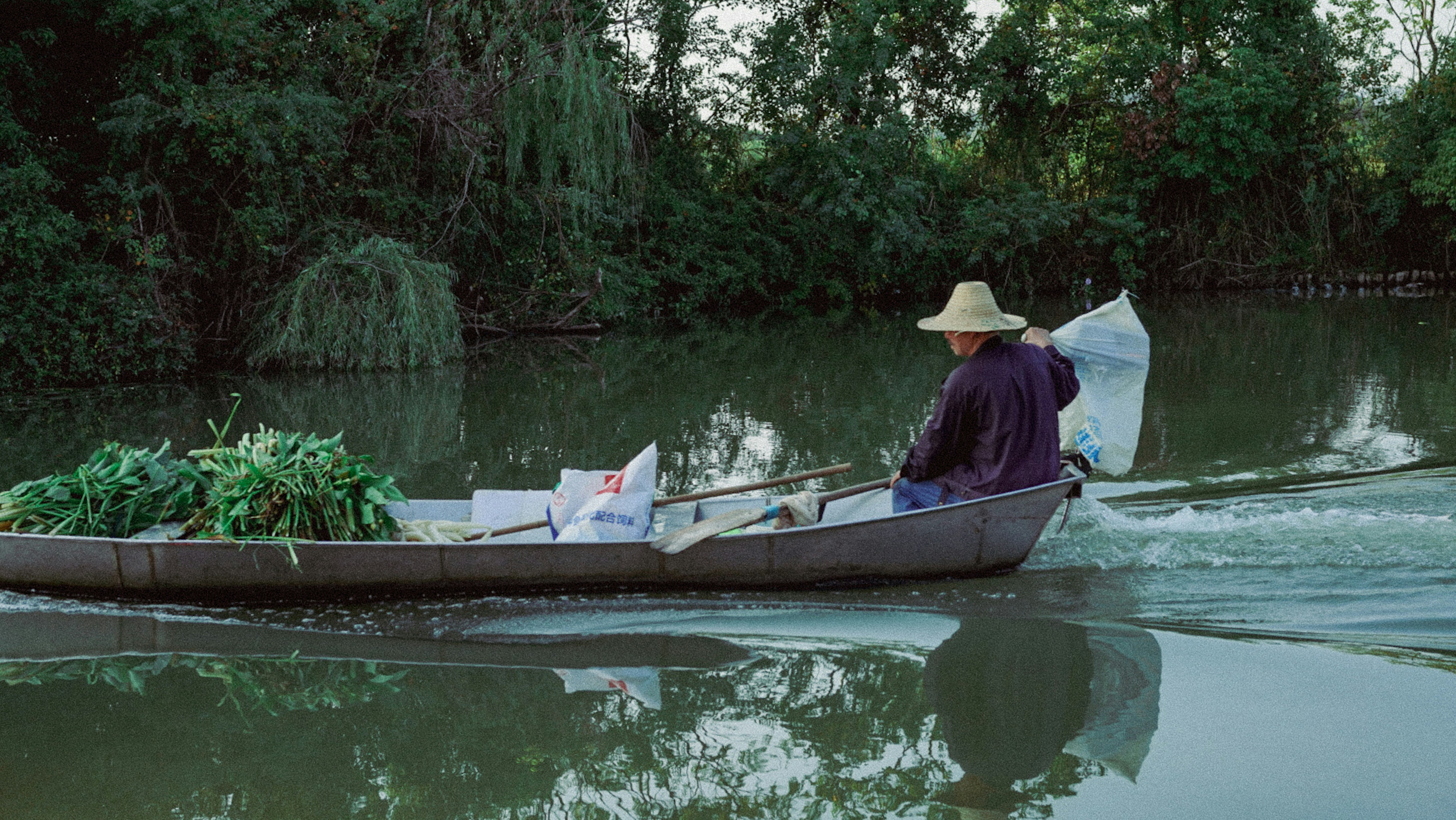 Overland Riverer: A lone boatman in calm waters