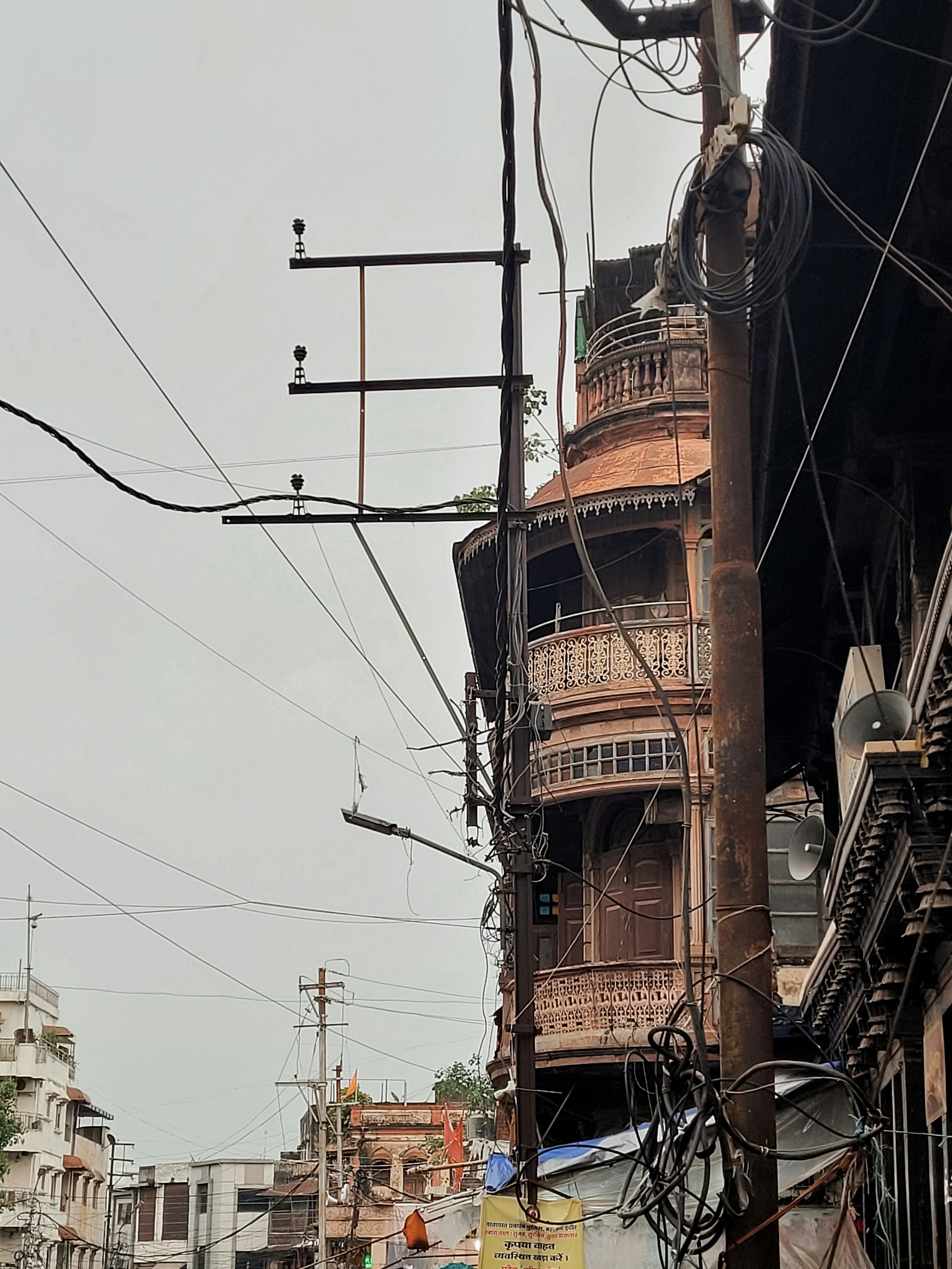 Wired Facade: Carved Balconies Surrounded by a Tangle of Cables