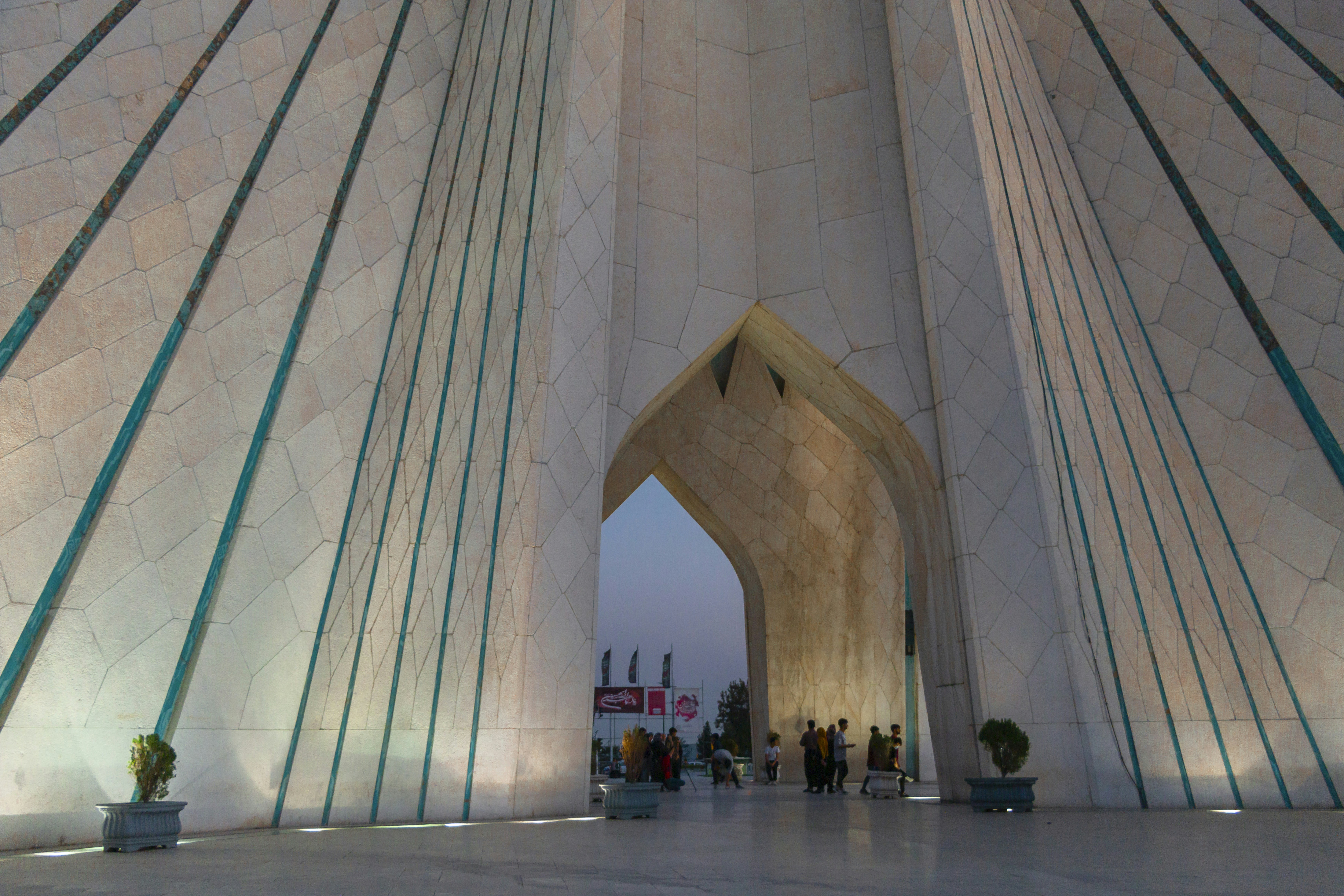 A large arched building with people walking around photo – Free ...
