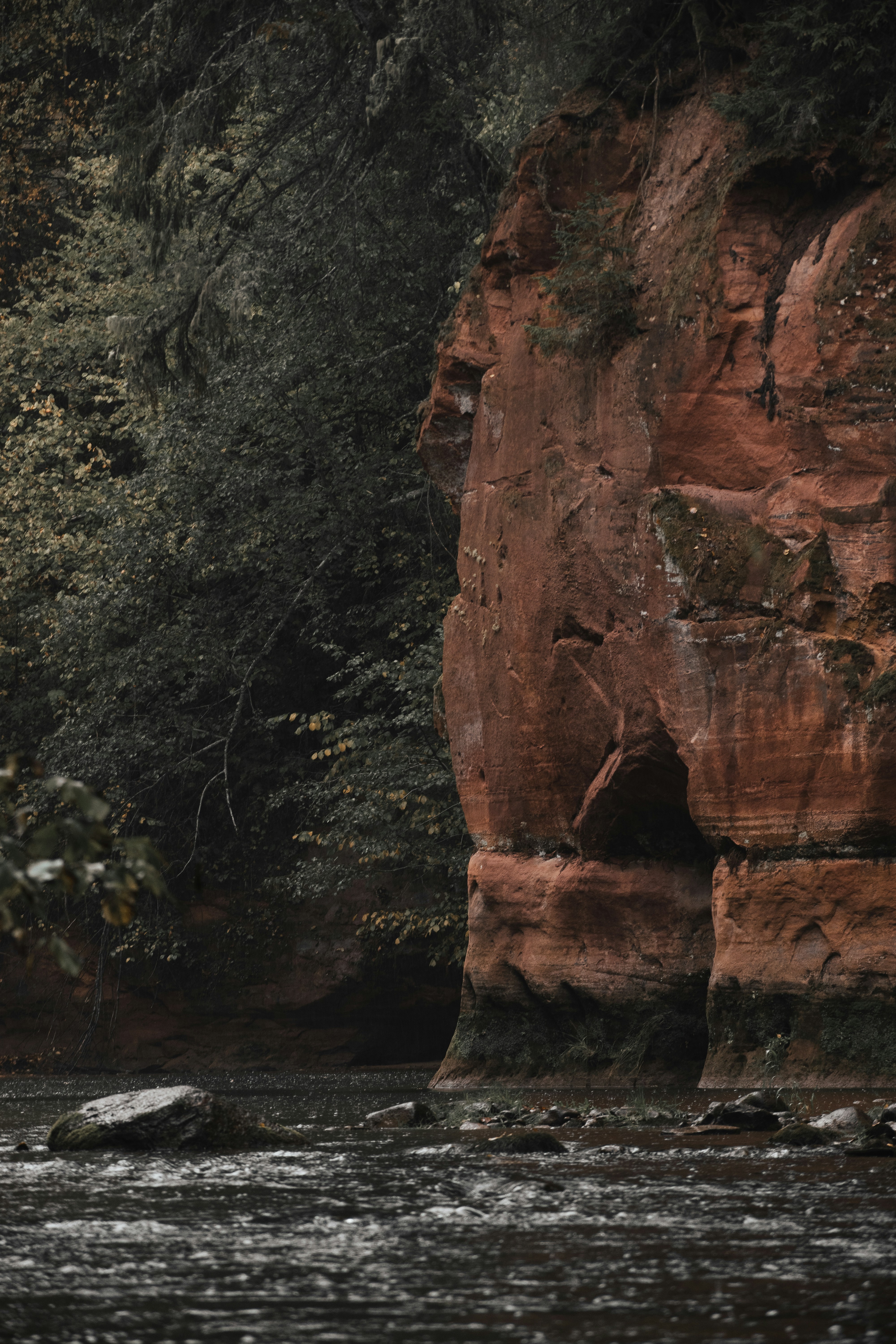 Red Cliff Overlooking the Quiet River at Dusk