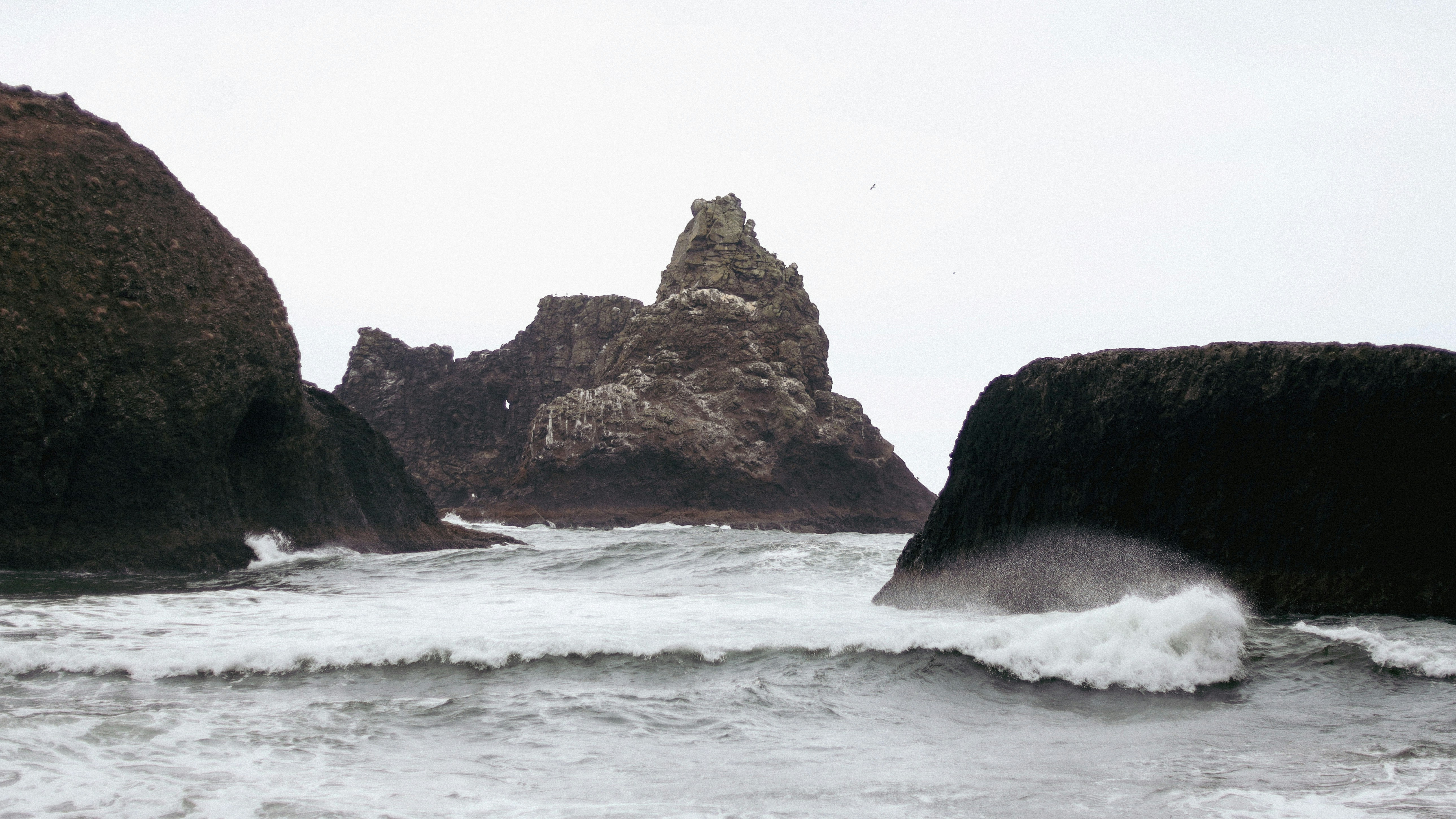 My wife and I discovered this hidden beach on our honeymoon. So much fun | waves crashing against a rock formation