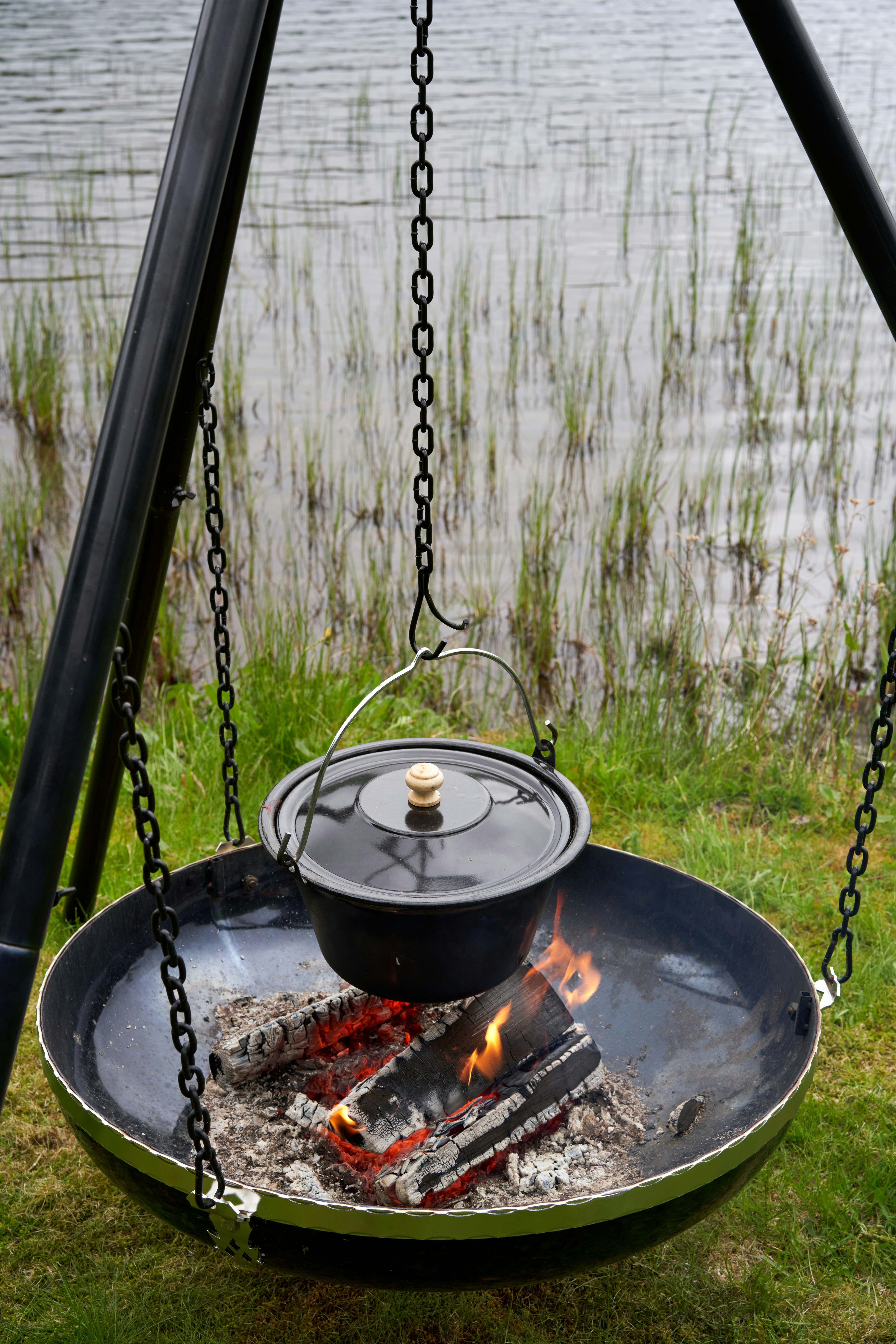 Centered Ember: A Pot on a Hanging Cooker Over Quiet Coals