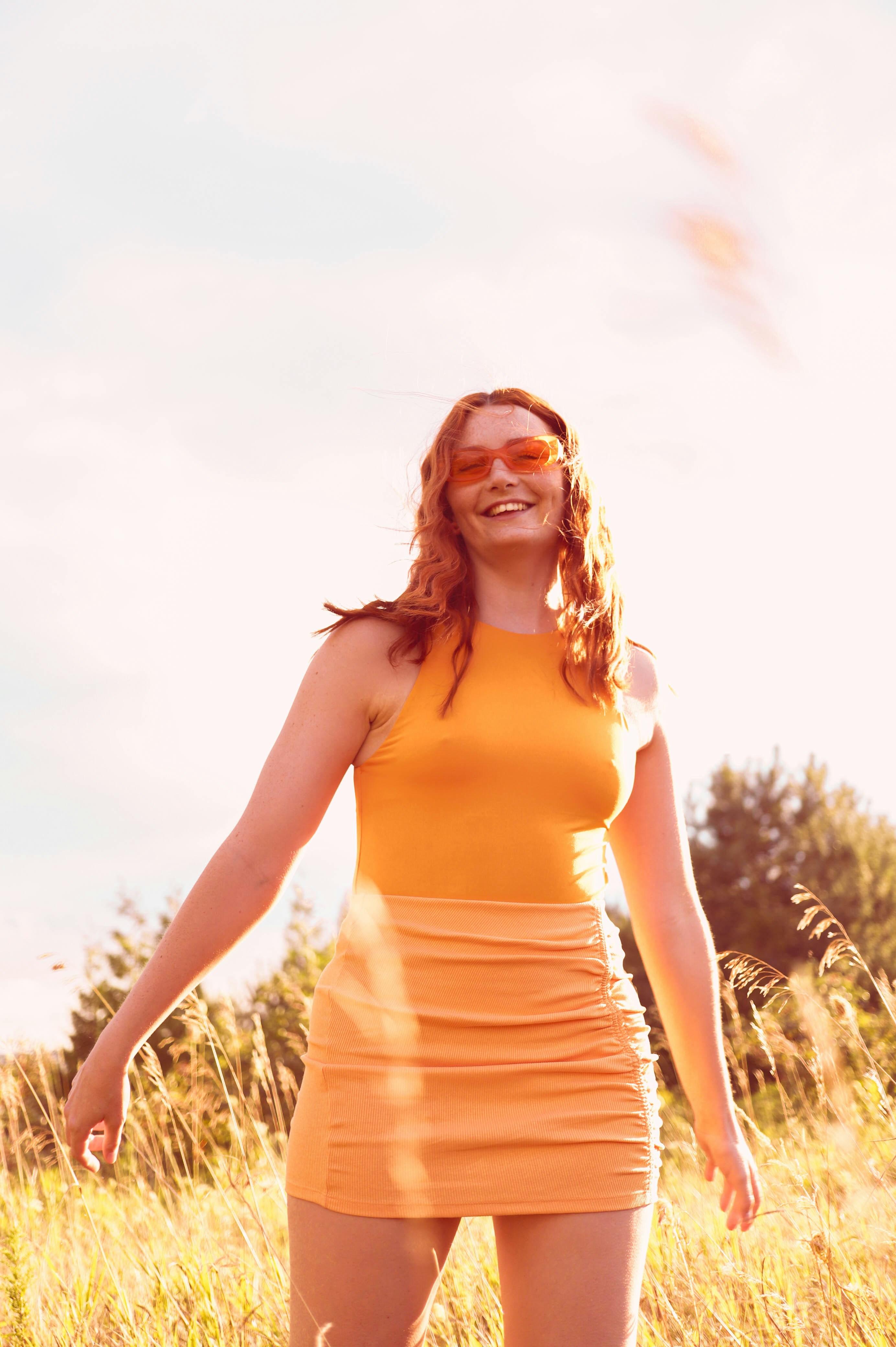 Tangerine Glow: A Sunlit Portrait in a Field of Tall Grass