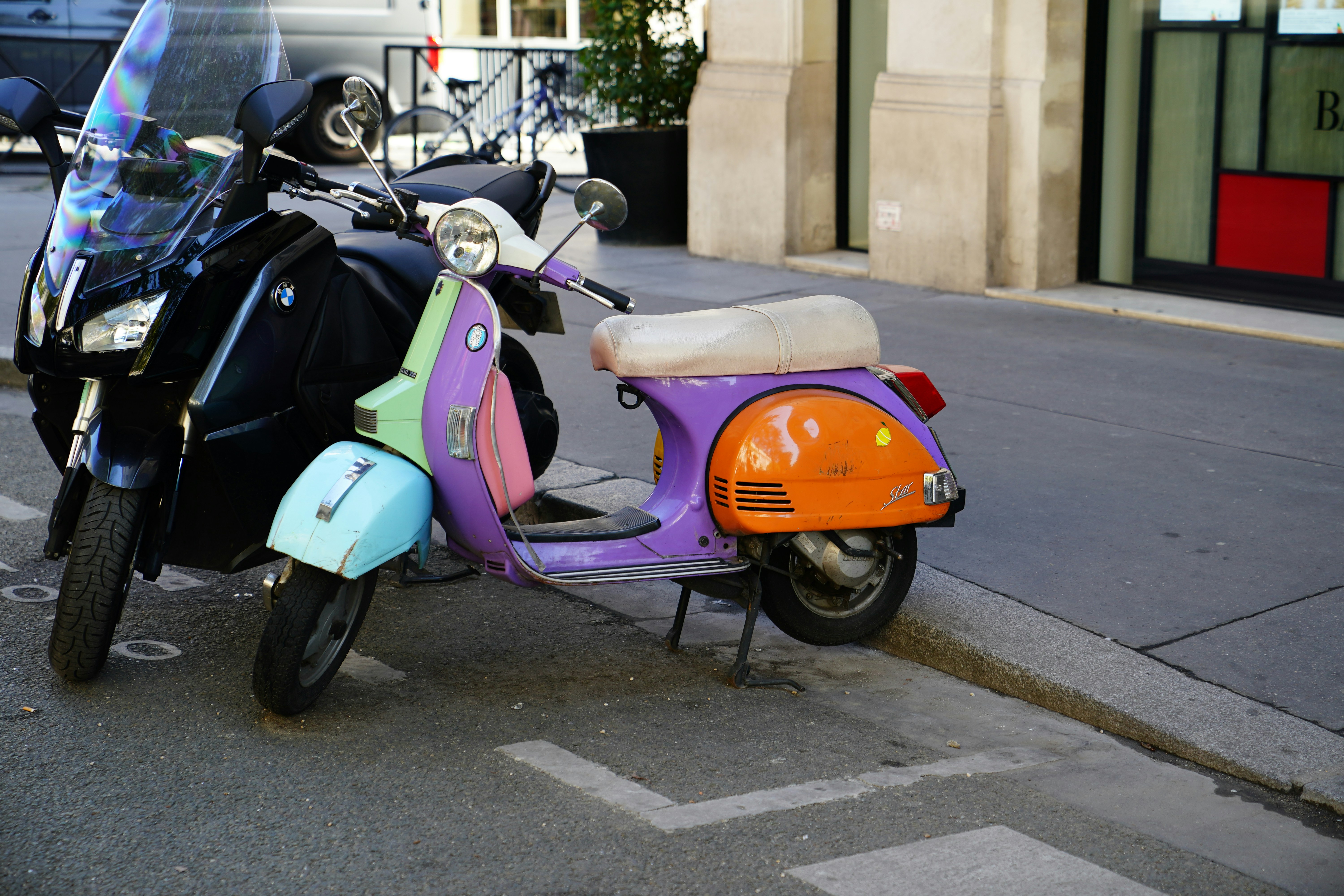 Pastel Rover: A Colorful Scooter Resting by the Street