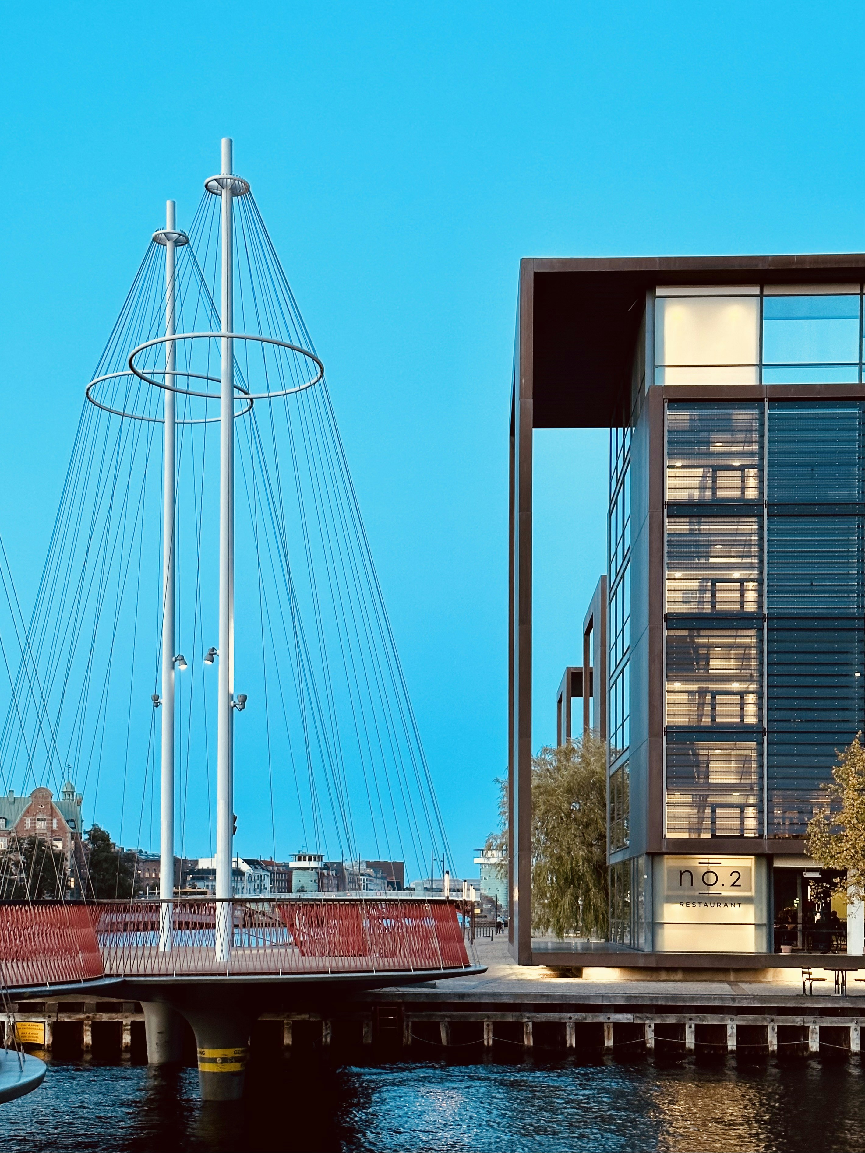 a bridge over water with a building in the background