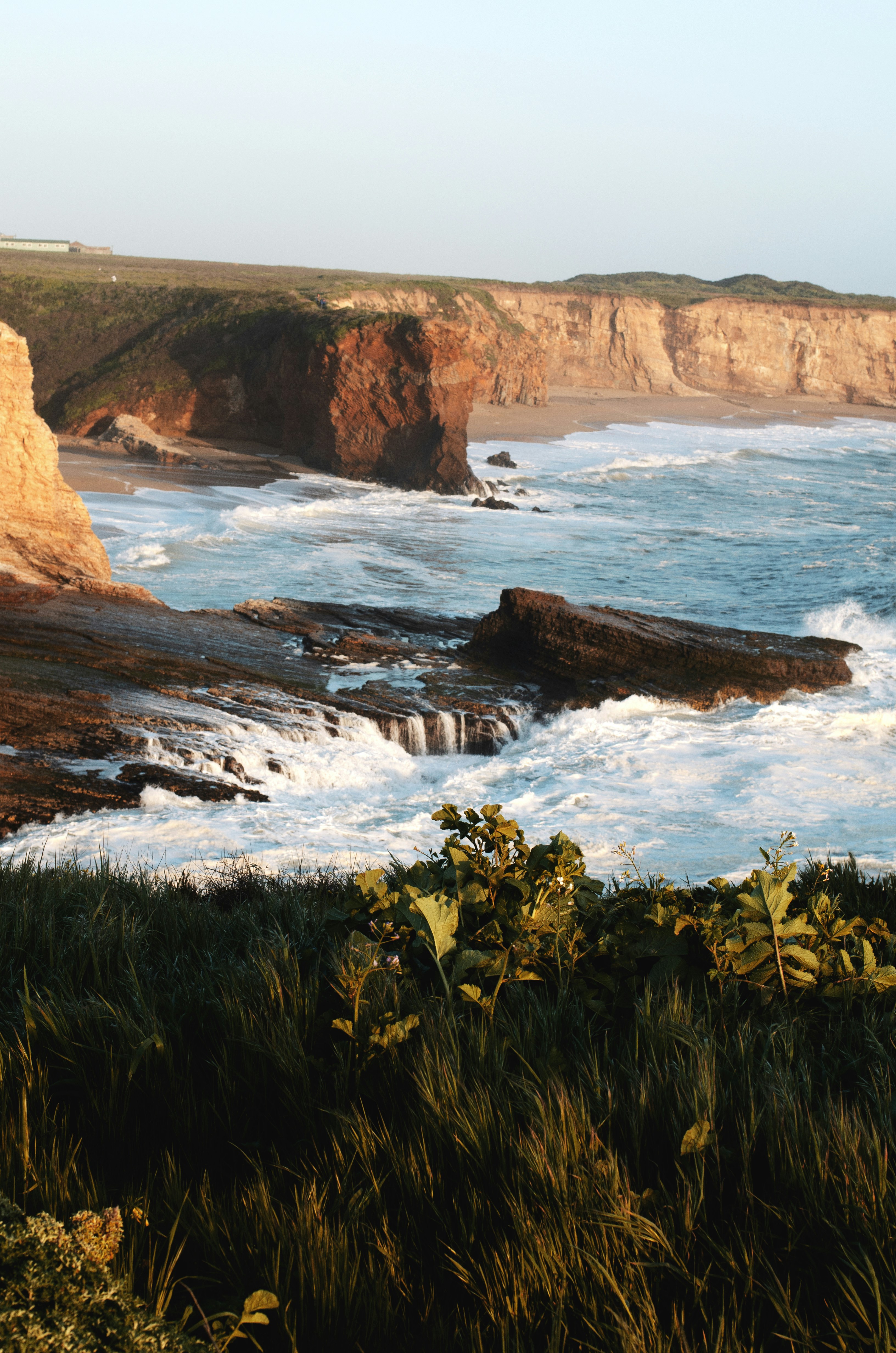Amber Cliffs, Blue Breakers: Evening Light over a Rugged Coast
