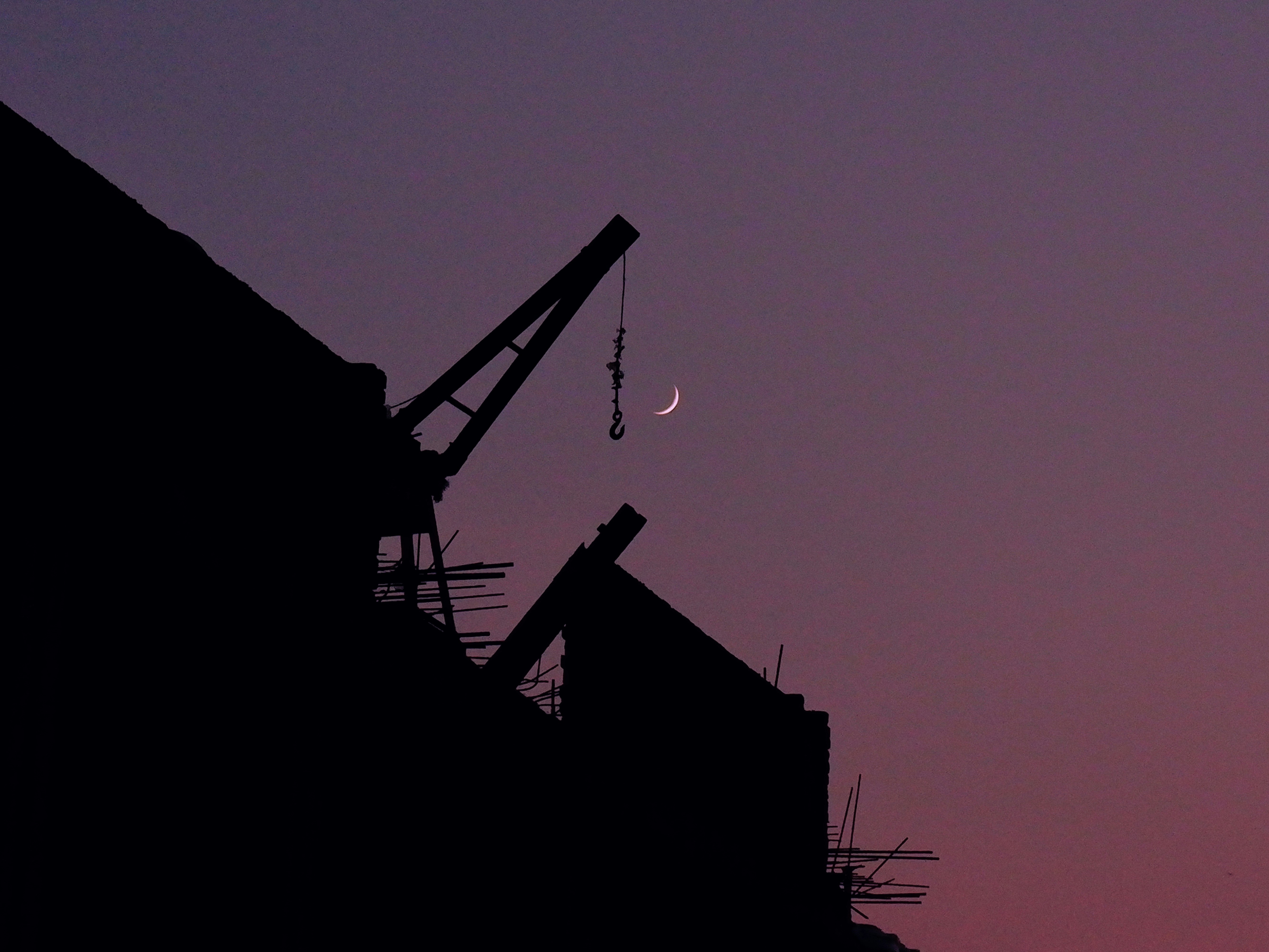Crescent Moon Over Ruined Skyline at Dusk