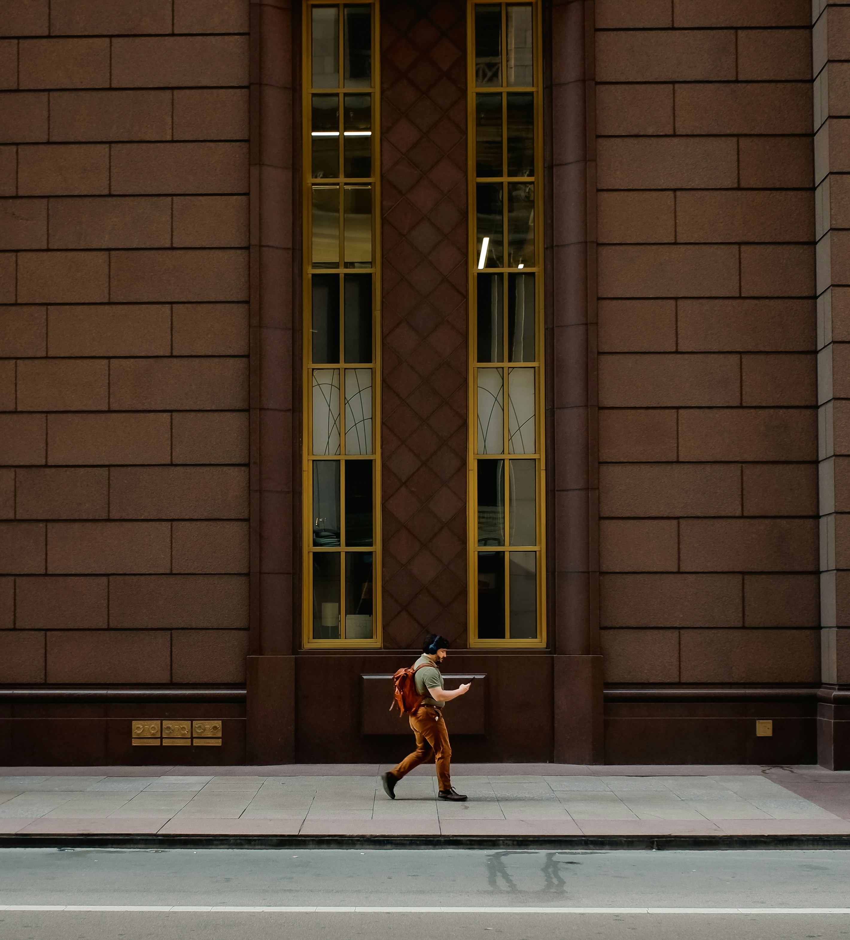 Solitary Stride Along Urban FacadeBLUE