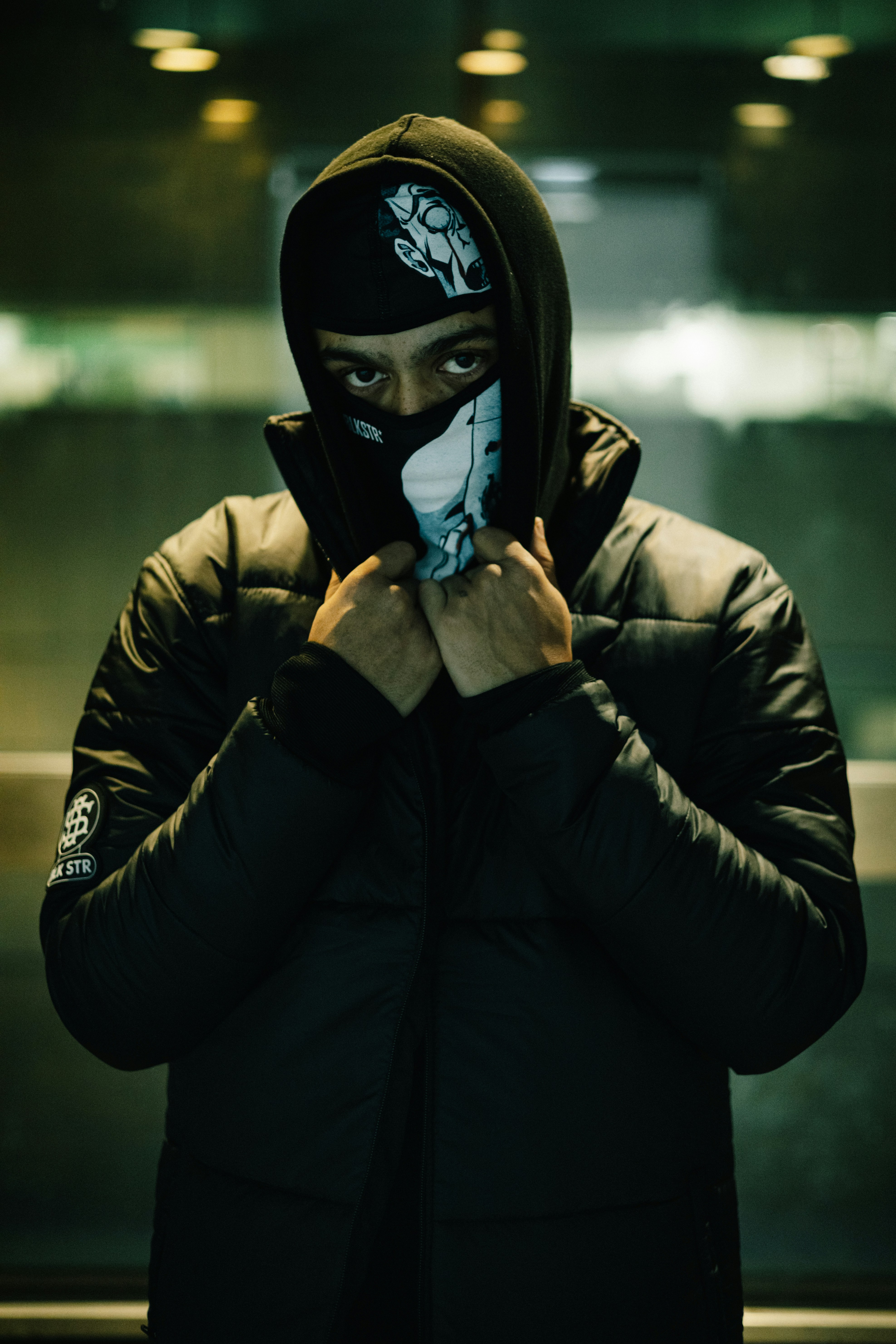 A person wearing a mask and holding a phone to their ear photo – Free ...