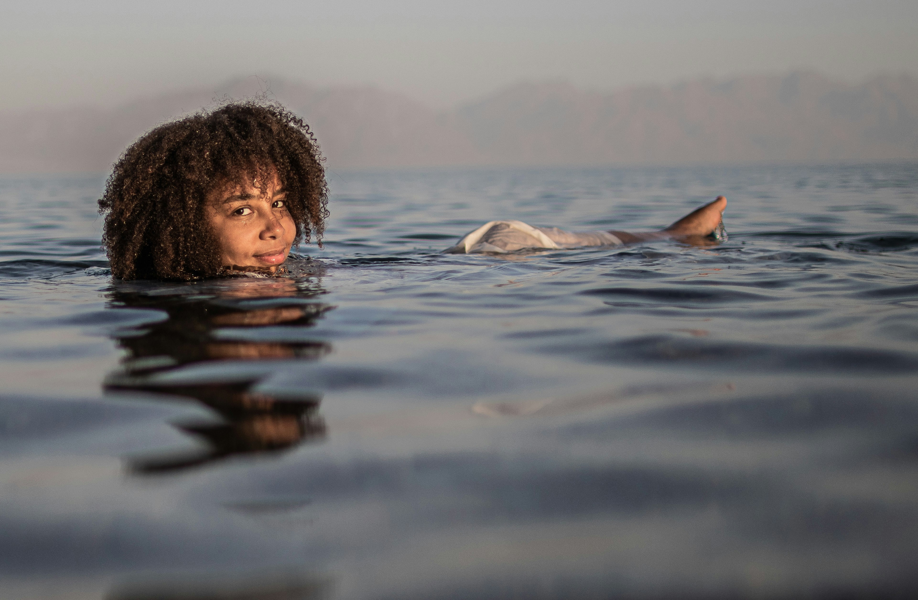 Dawn Gaze: A Swimmer Emerges from the Glassy Sea