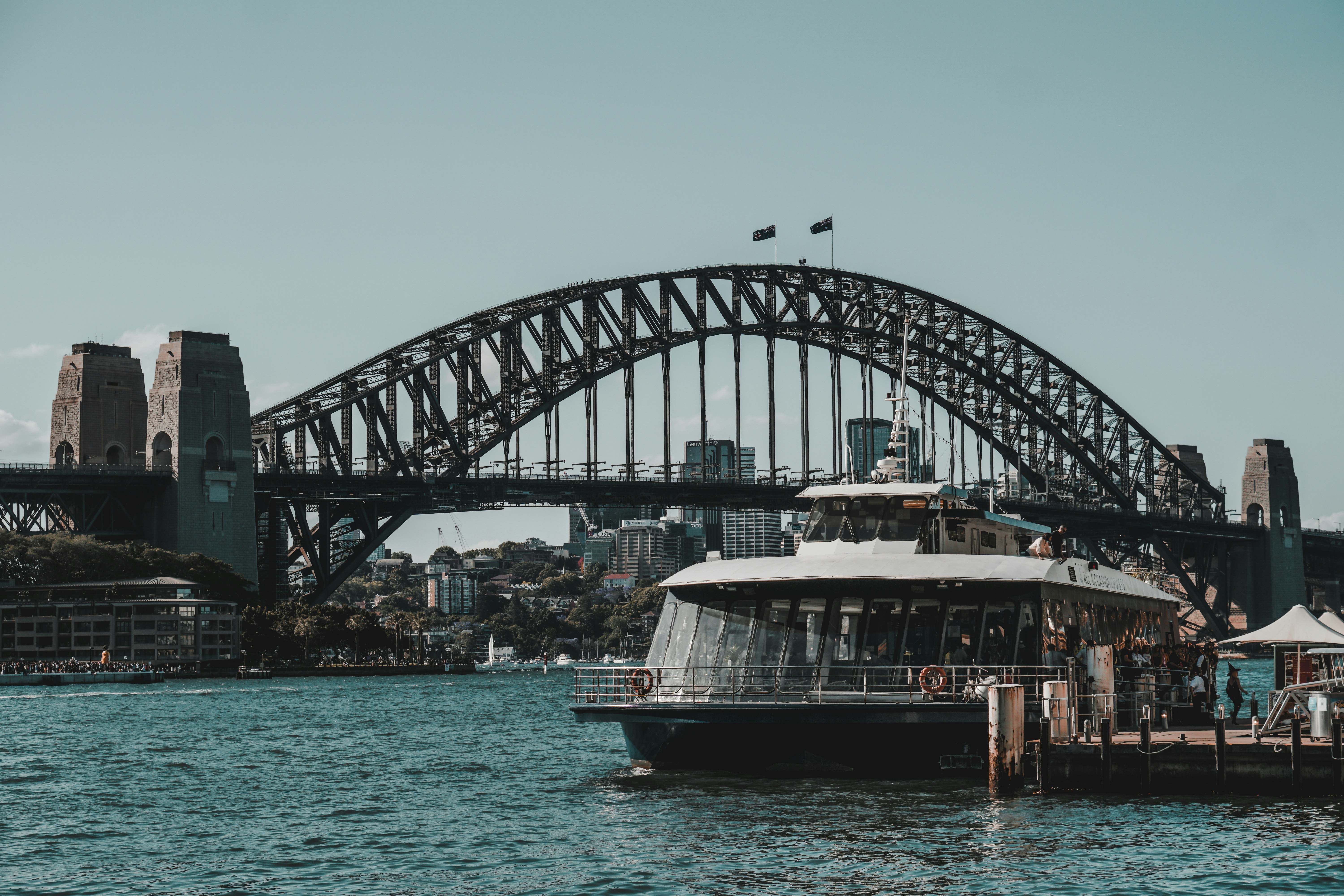 A boat in the water with Sydney Harbour Bridge in the background photo ...