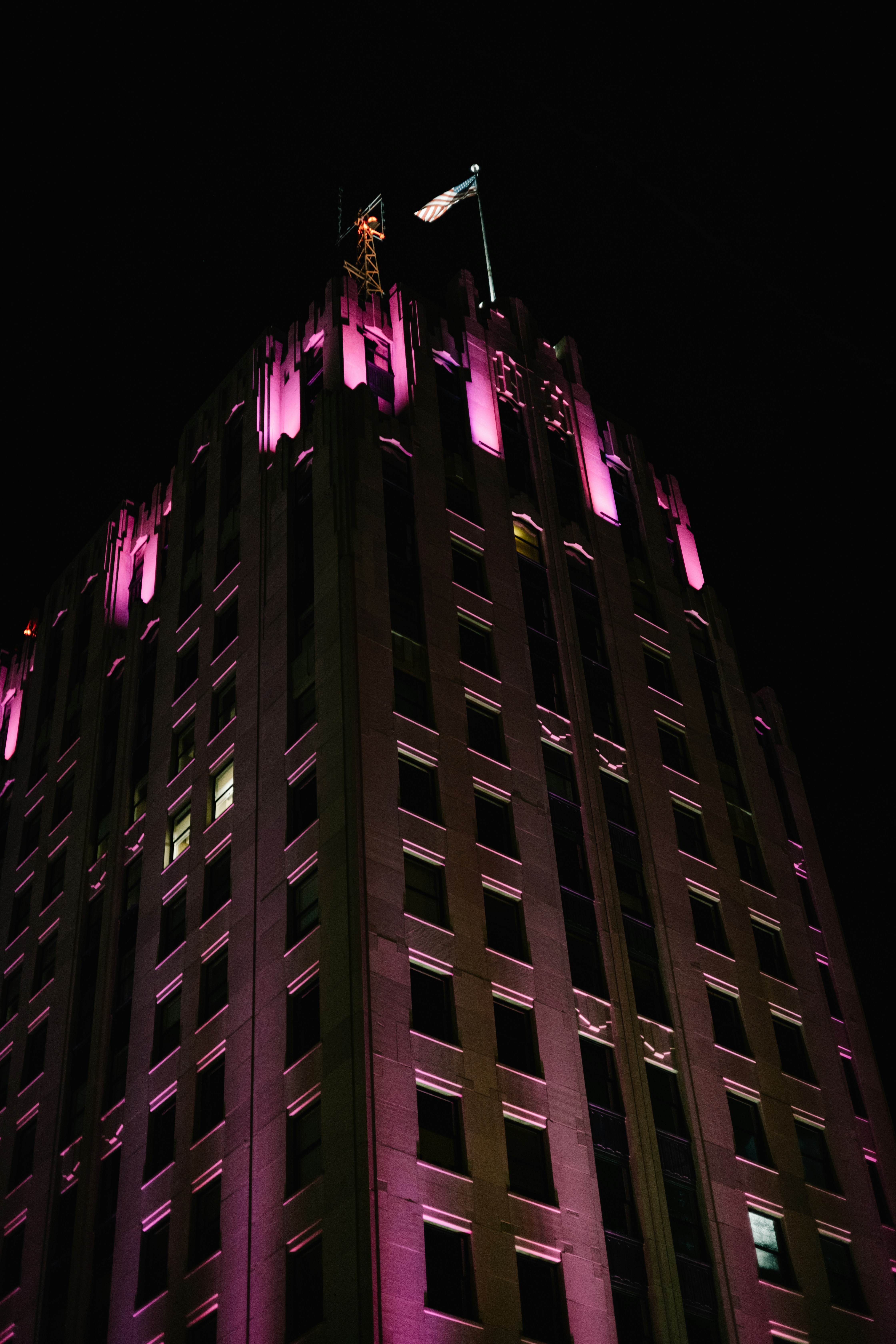 a tall building with a flag on top
