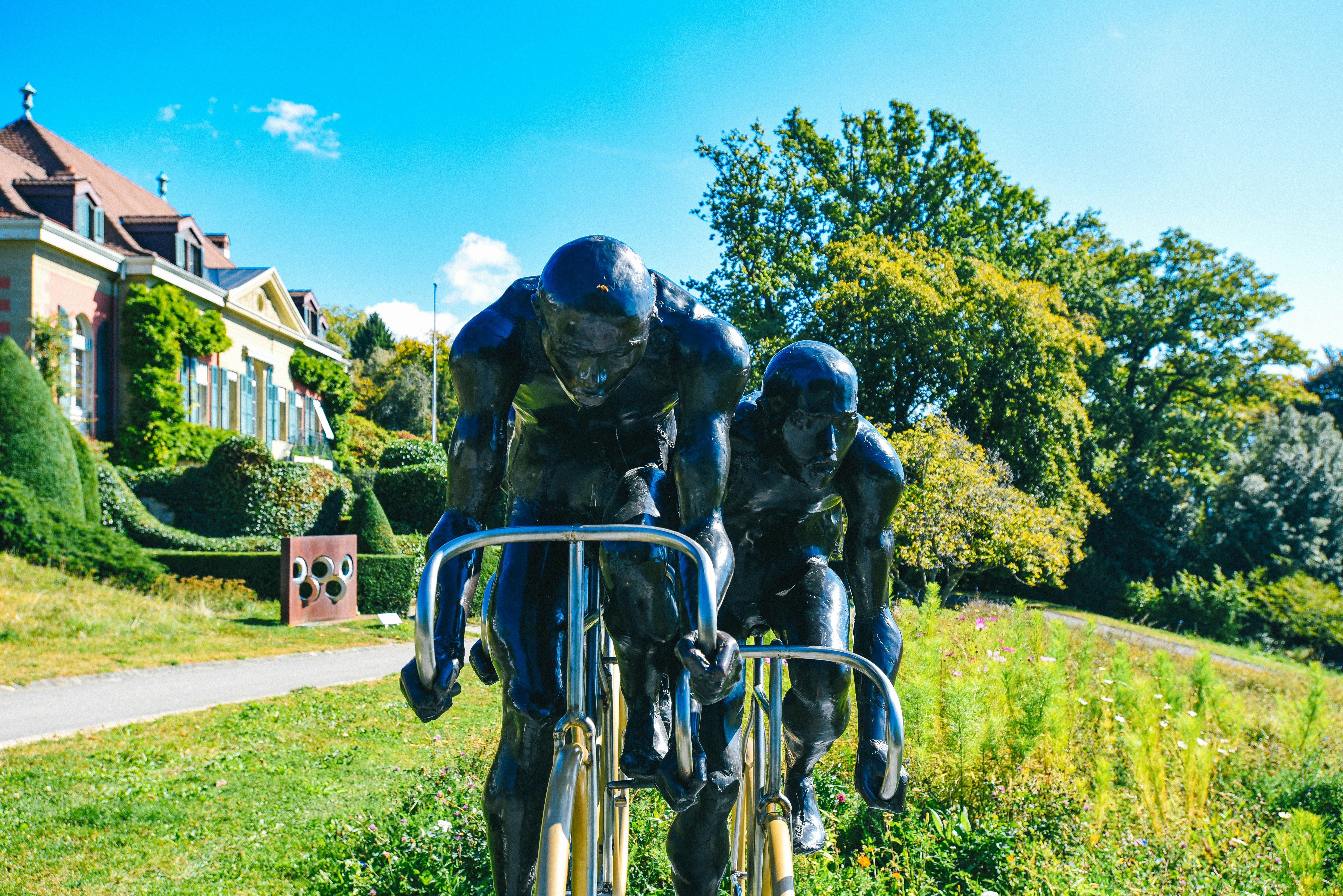 A statue of a person riding a bicycle photo – Free Human Image on Unsplash