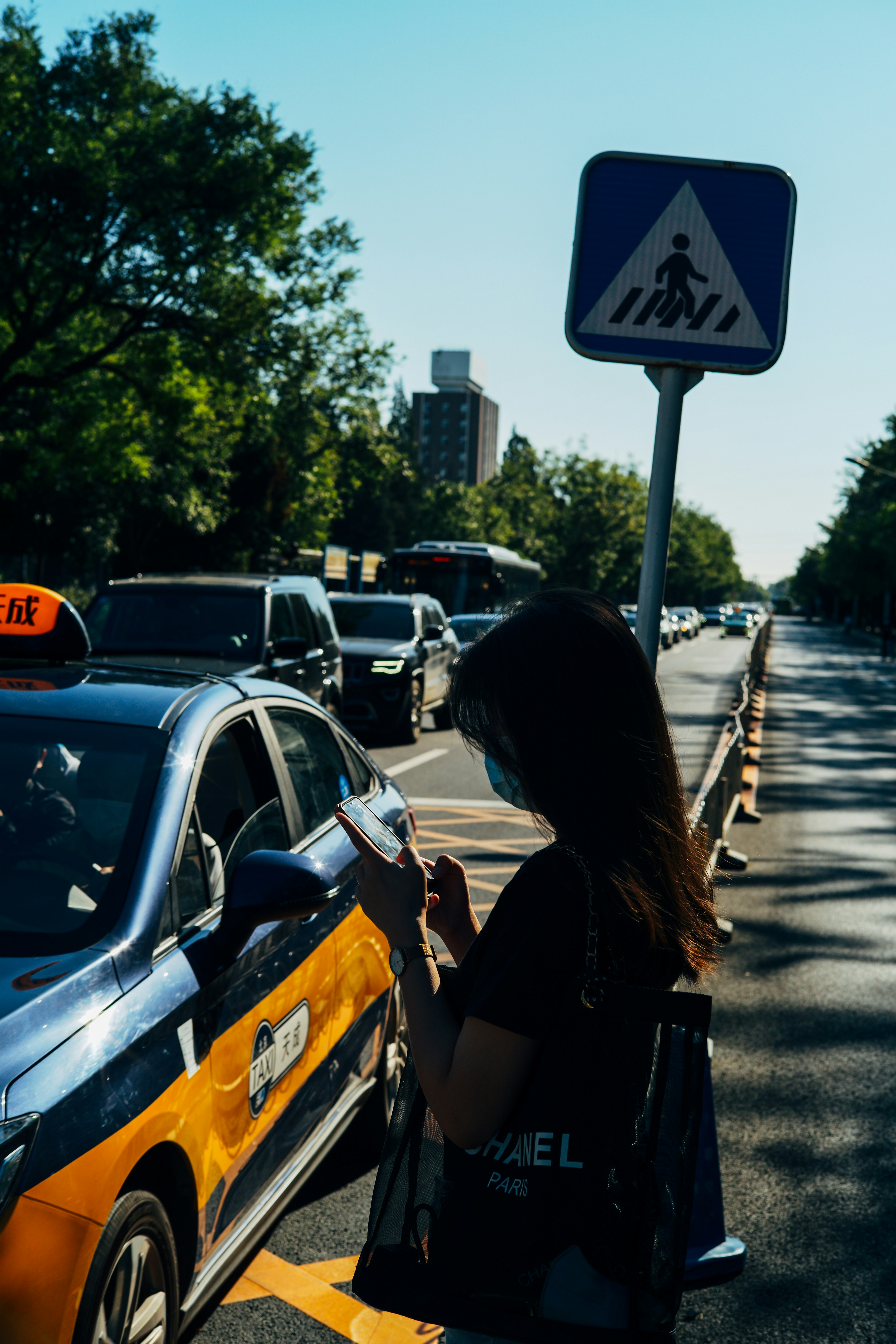 a person standing next to a yellow car